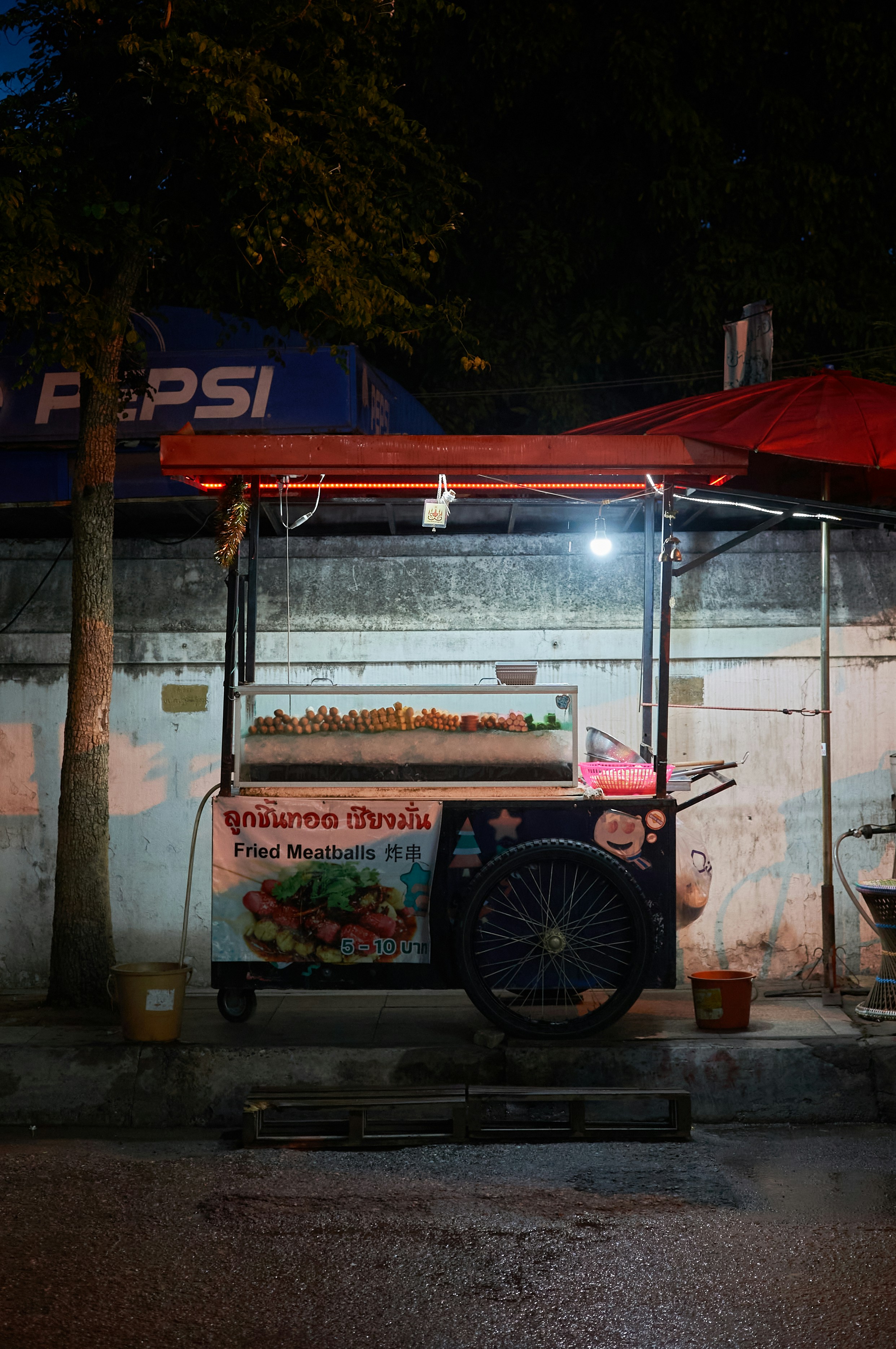 Street Cart at Night: Fried Meatballs Under Neon Glow