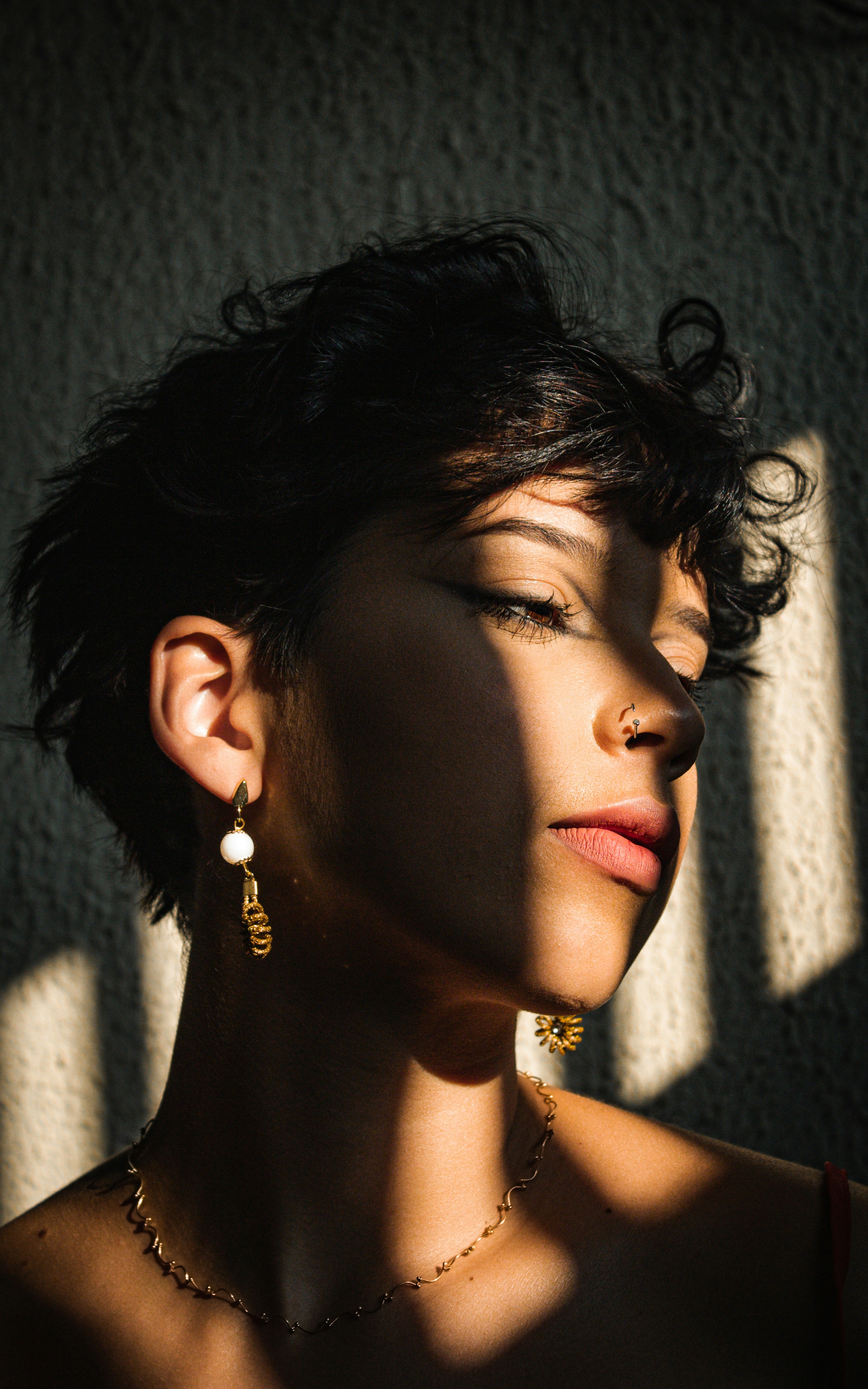 Sunlit Contours: A Portrait Sculpted by Shadow and Gold
