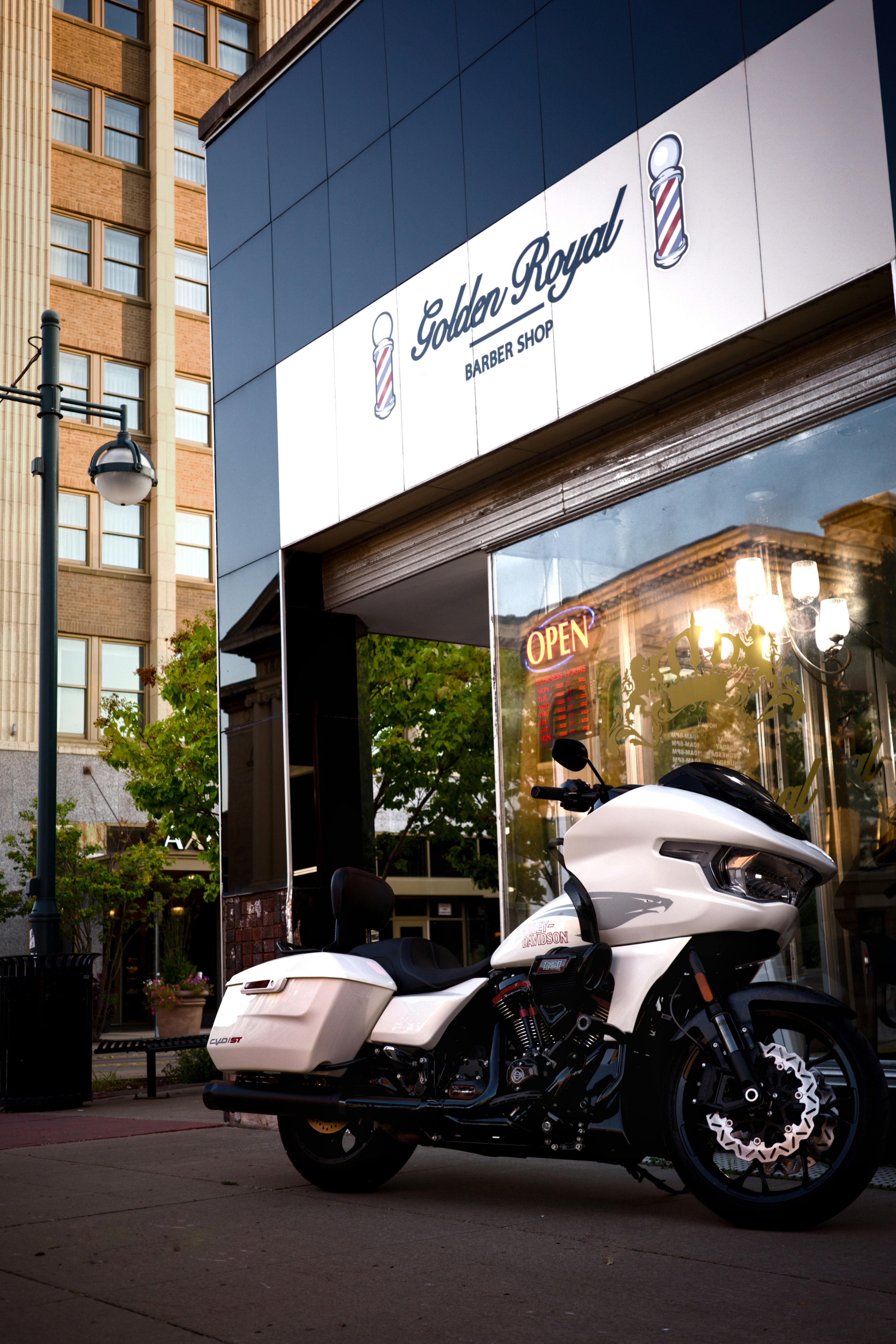 White Street Glide in Front of Golden Royal Barbershop Sign