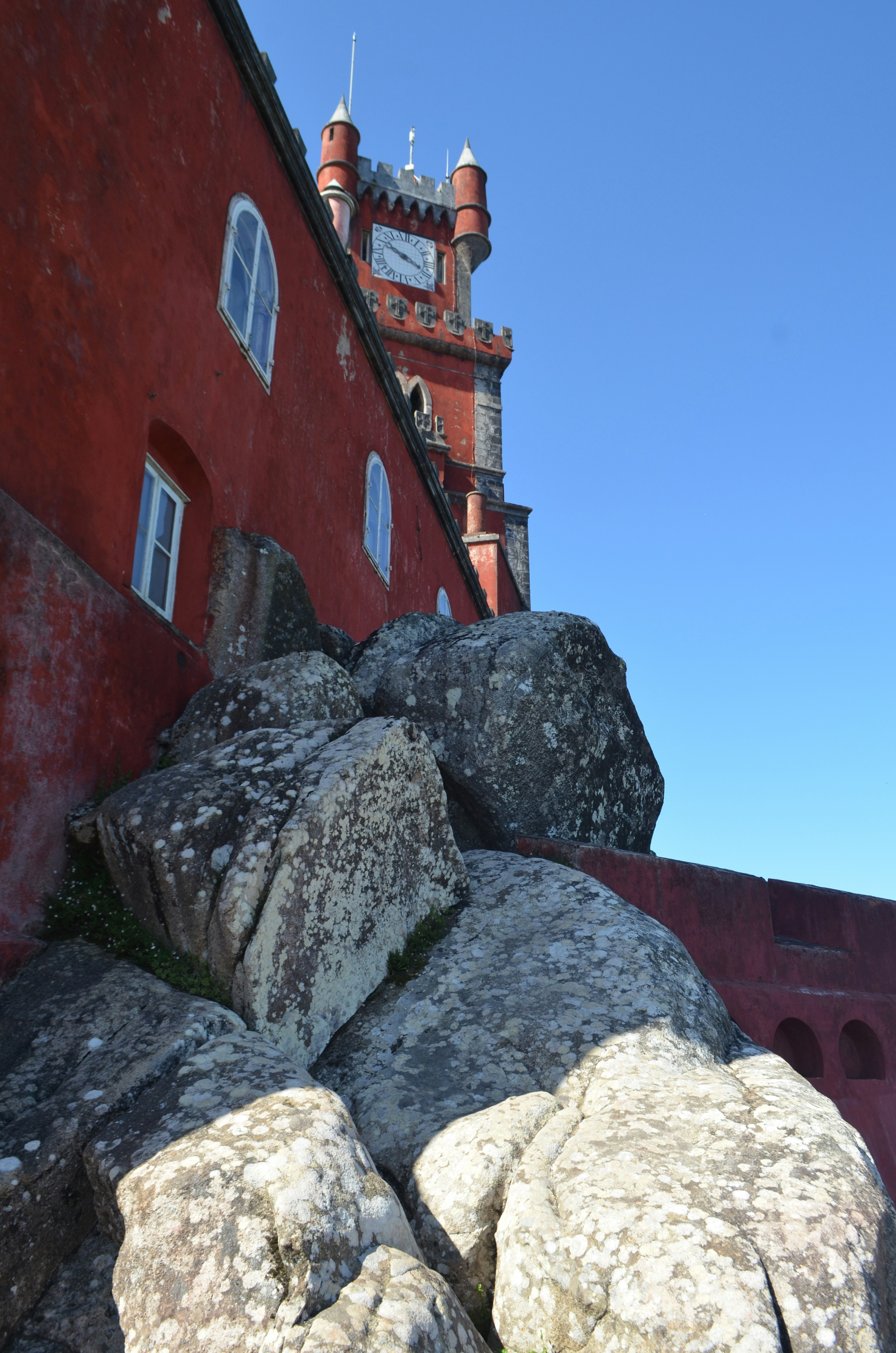 Crimson Keep on Granite: Cliffside Fortress Under a Pristine Sky