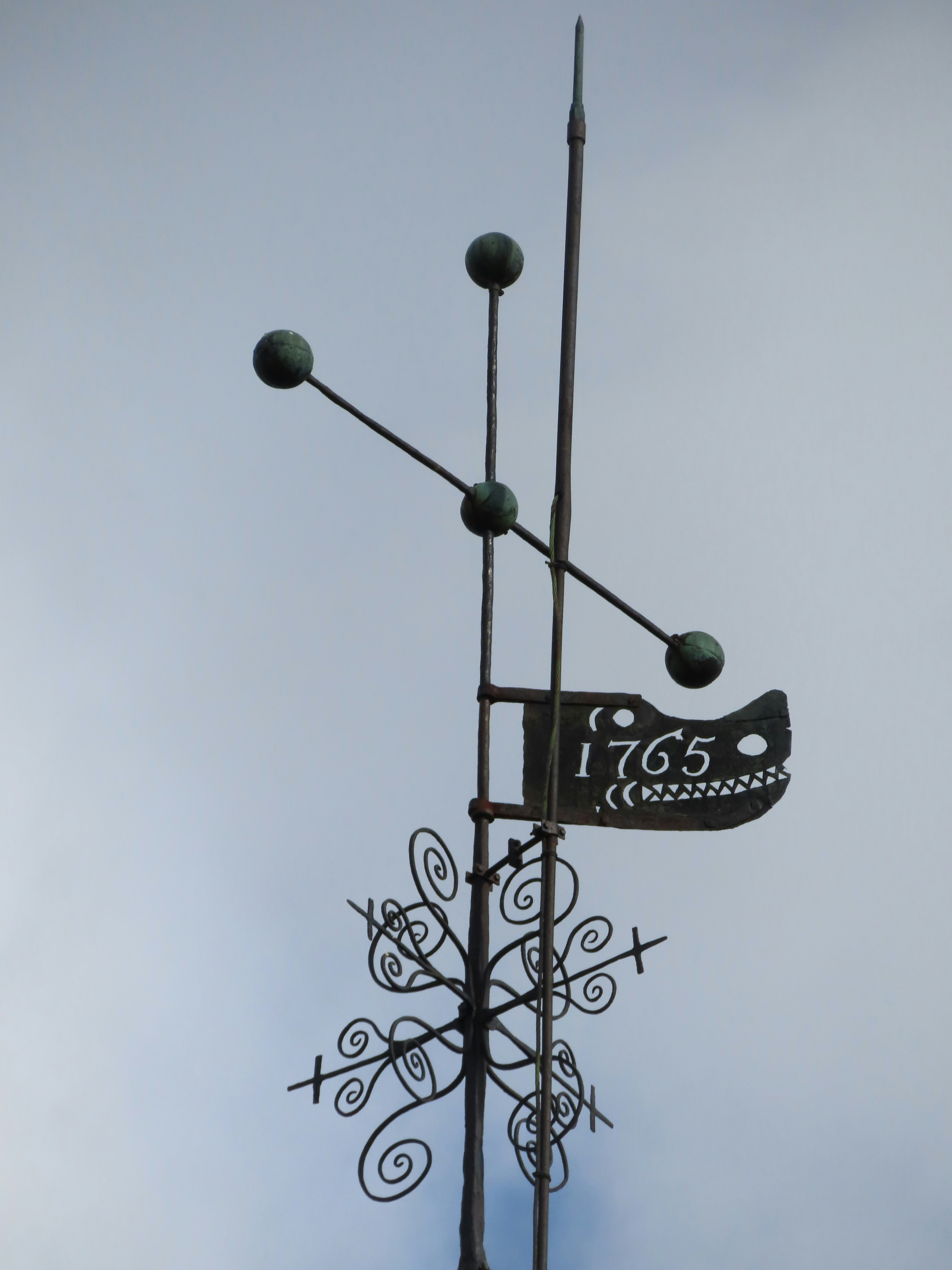 Dragonweath Vane: A Whimsical Year 1765 Sign Clings to the Sky