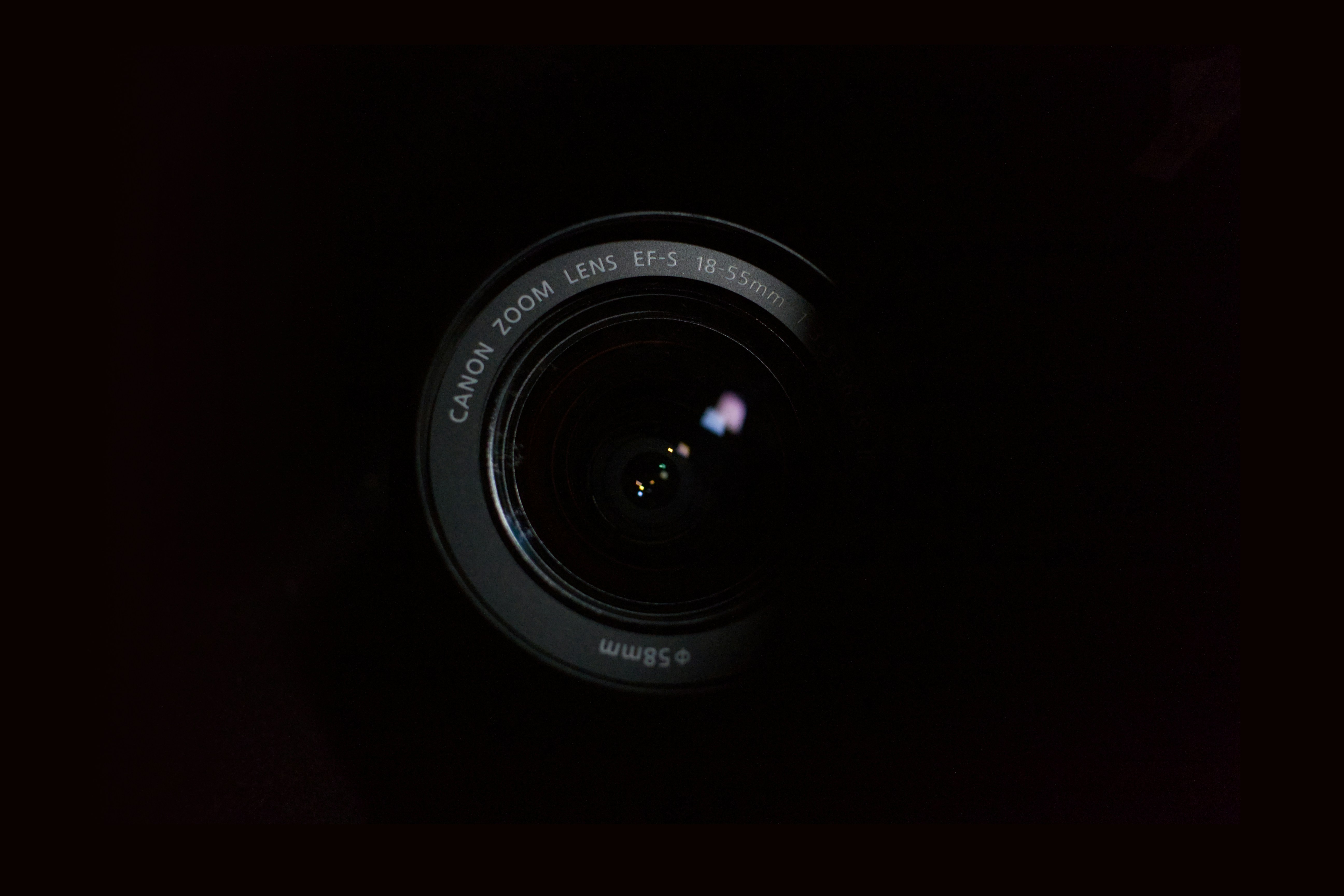 A camera lens in the dark with a black background photo – Free Camera ...
