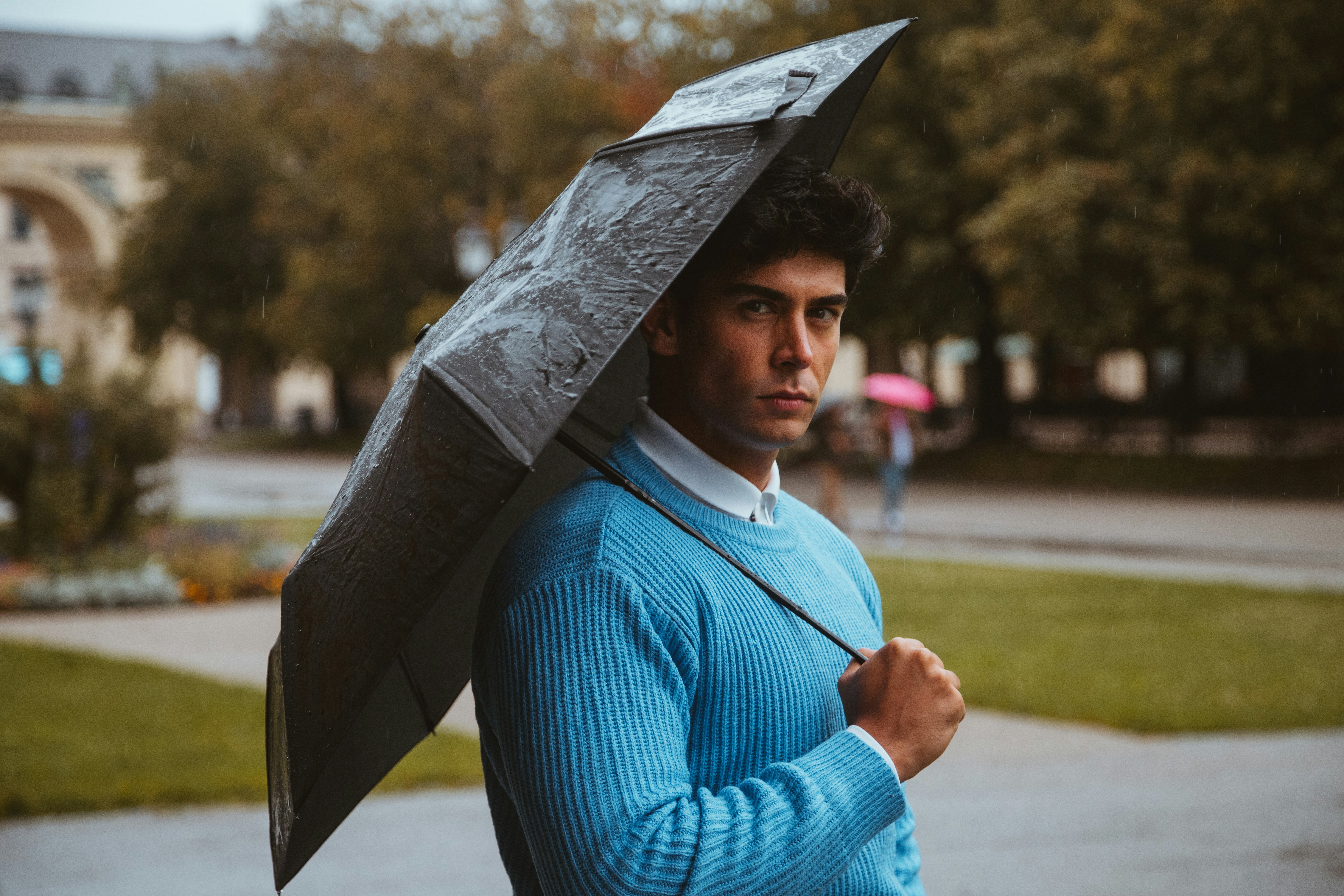 Rainy Gaze: A Quiet Portrait Under a Black Umbrella