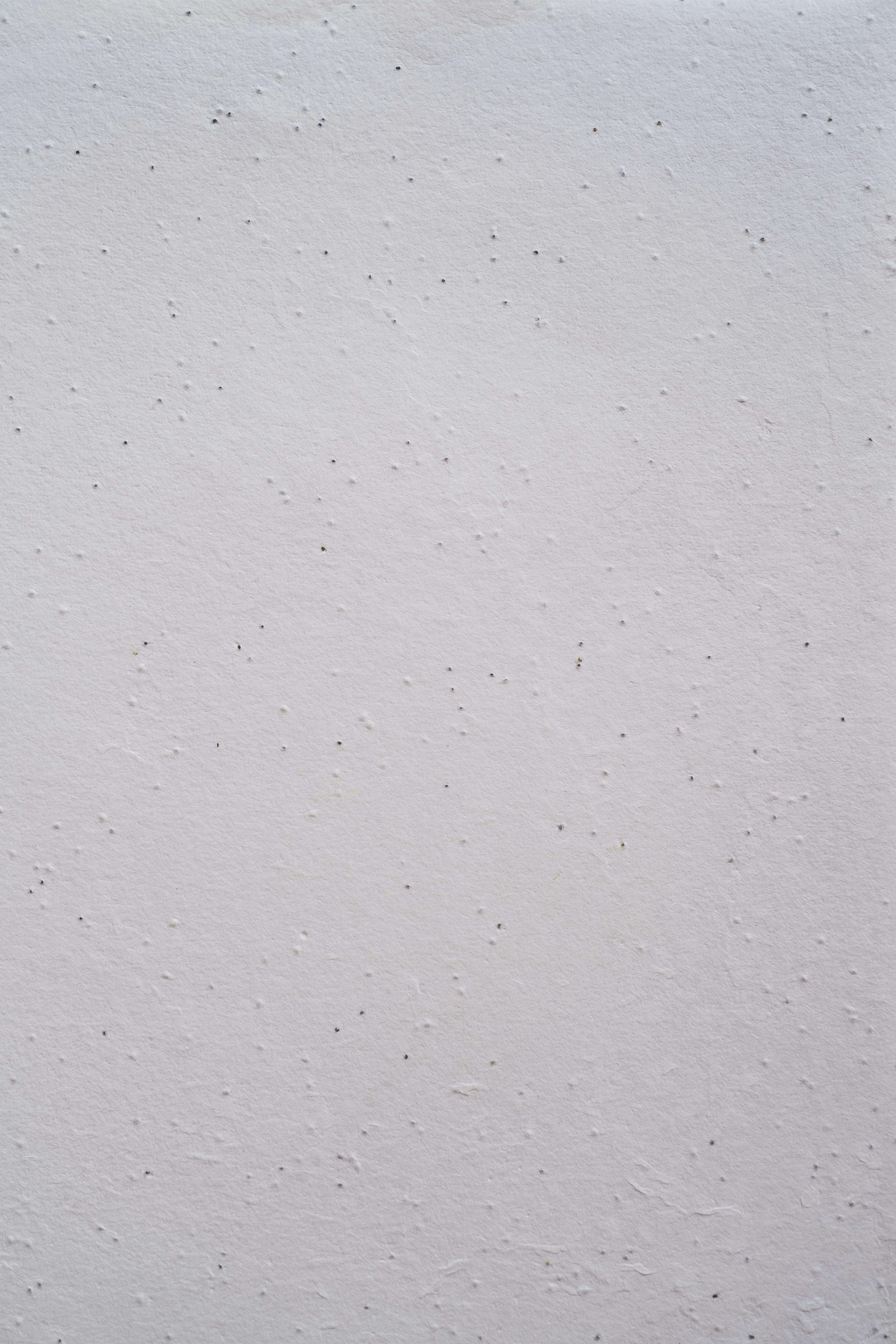 A red fire hydrant sitting on the side of a white wall photo – Free ...