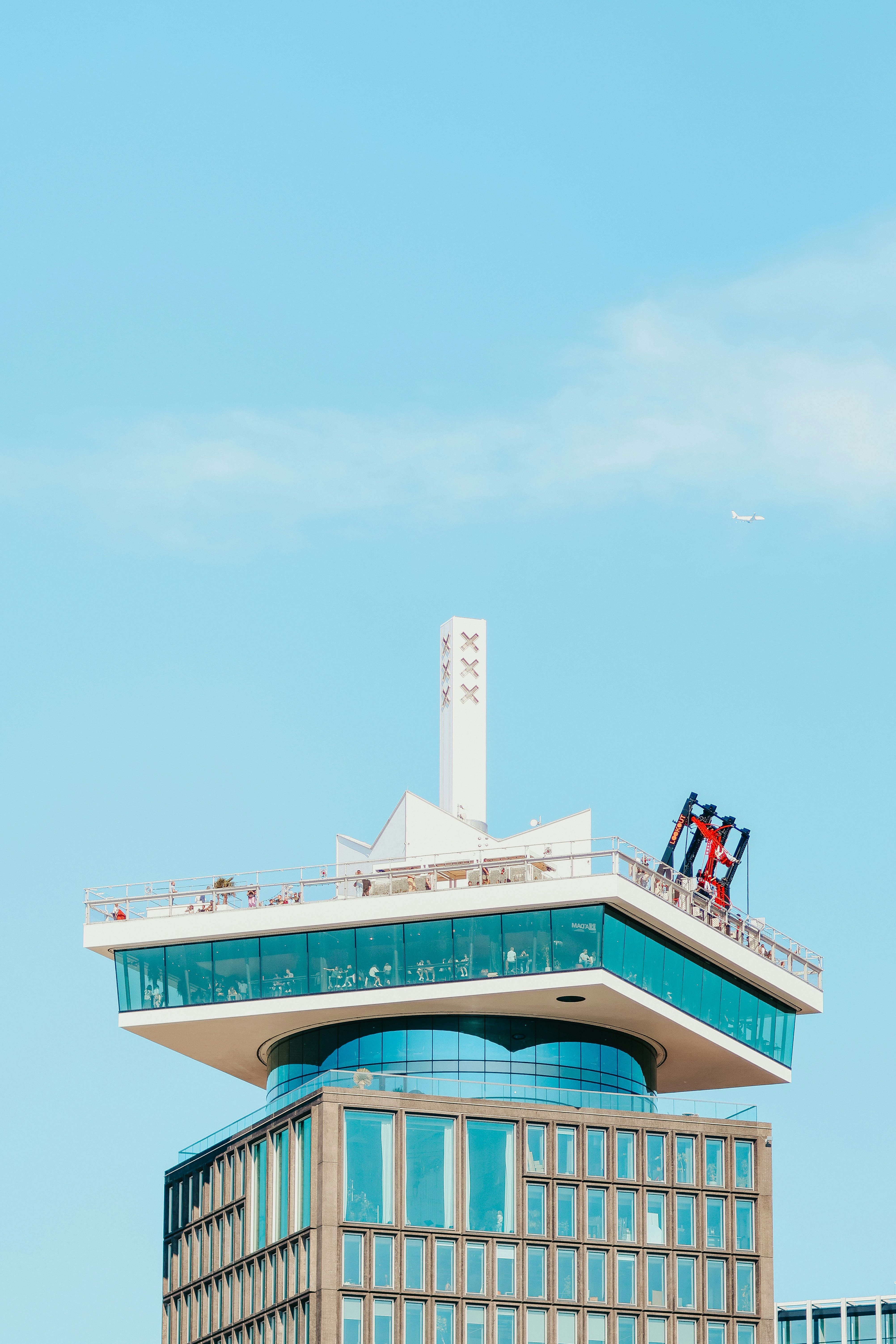 A tall building with a sky scraper on top of it photo – Free A'dam ...