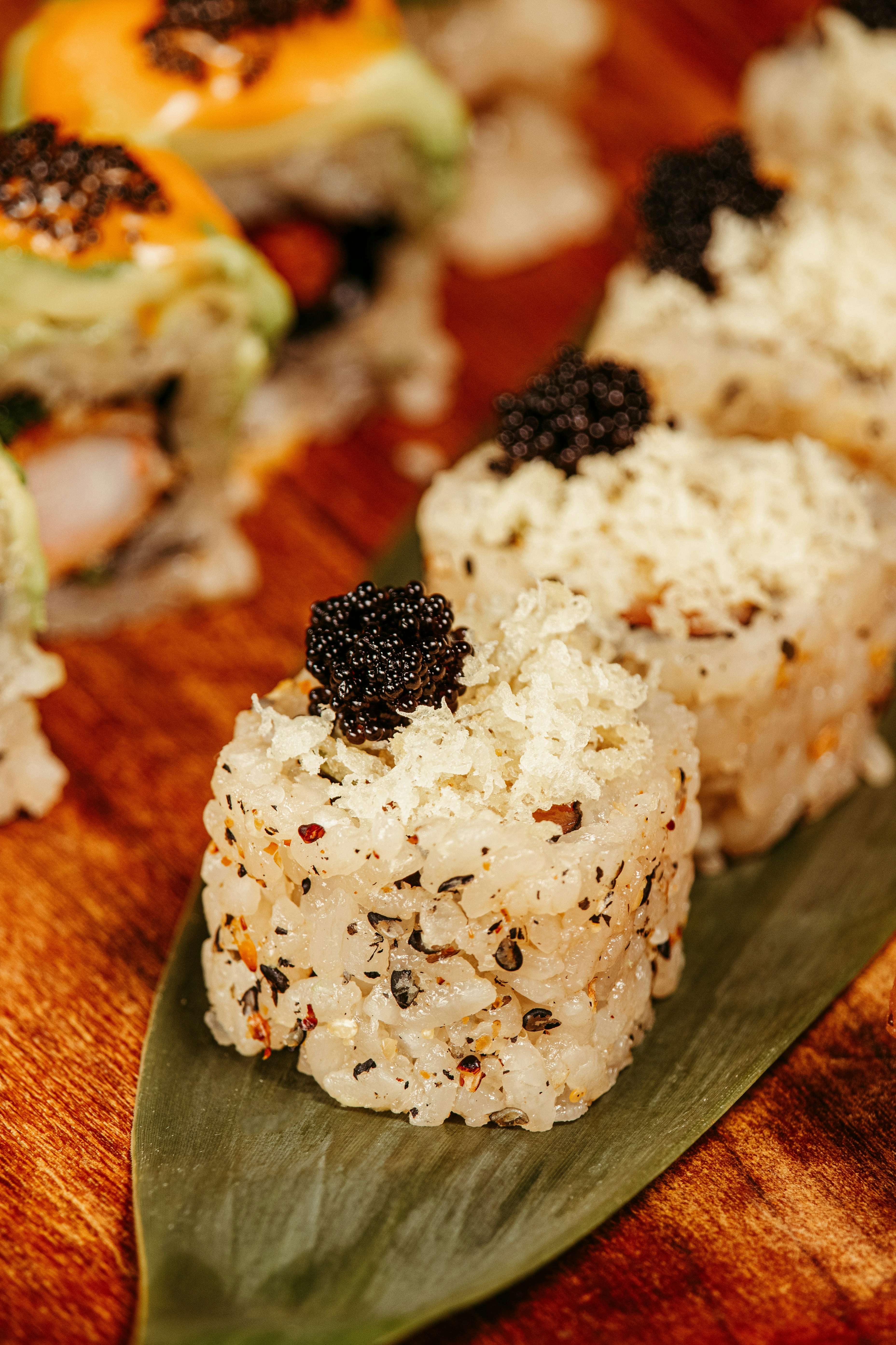 Leaf-Plate Sushi Bites: Sesame-Studded Rolls Crowned with Black Tobiko