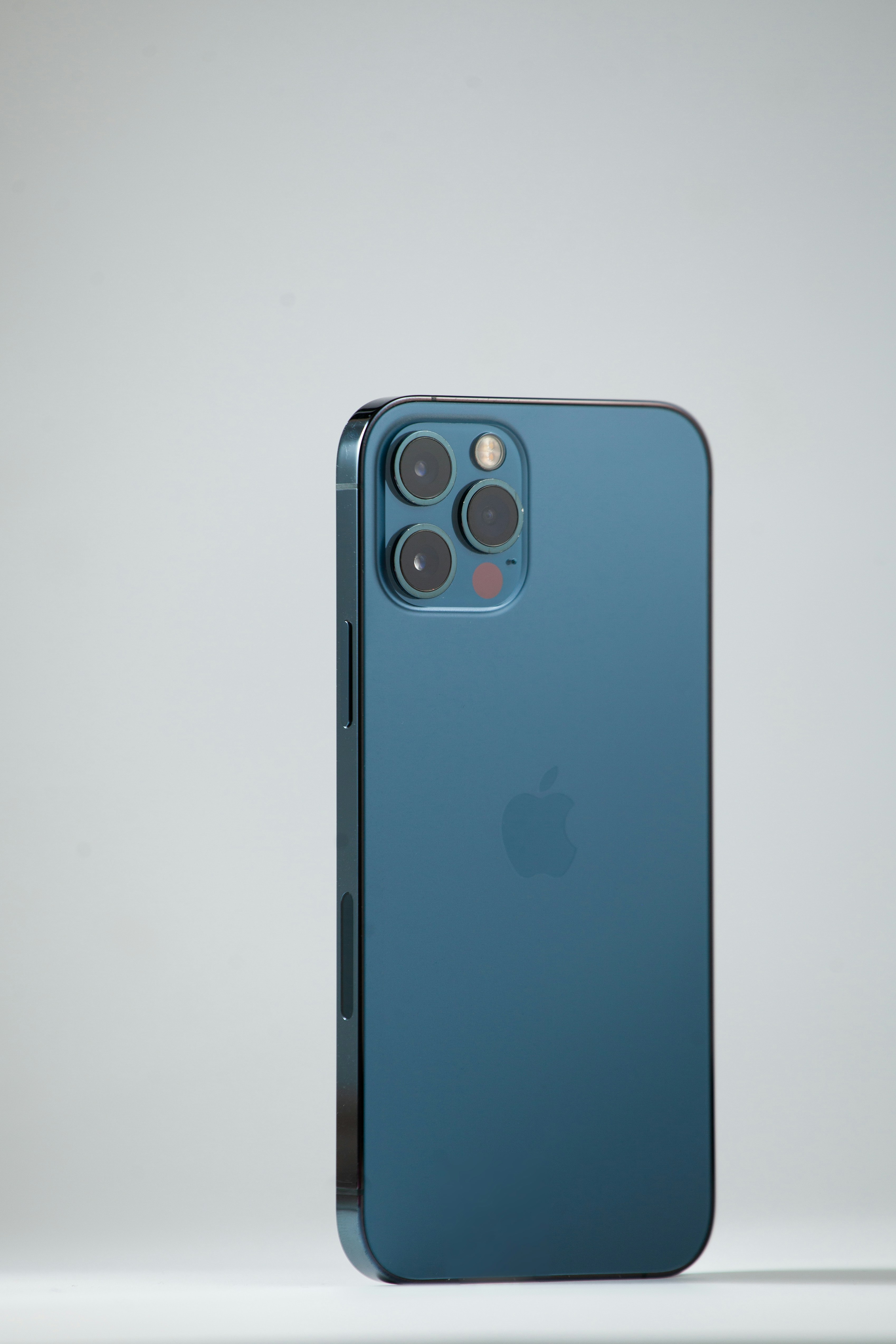 A blue iPhone case sitting on top of a table photo – Free Cell phone ...