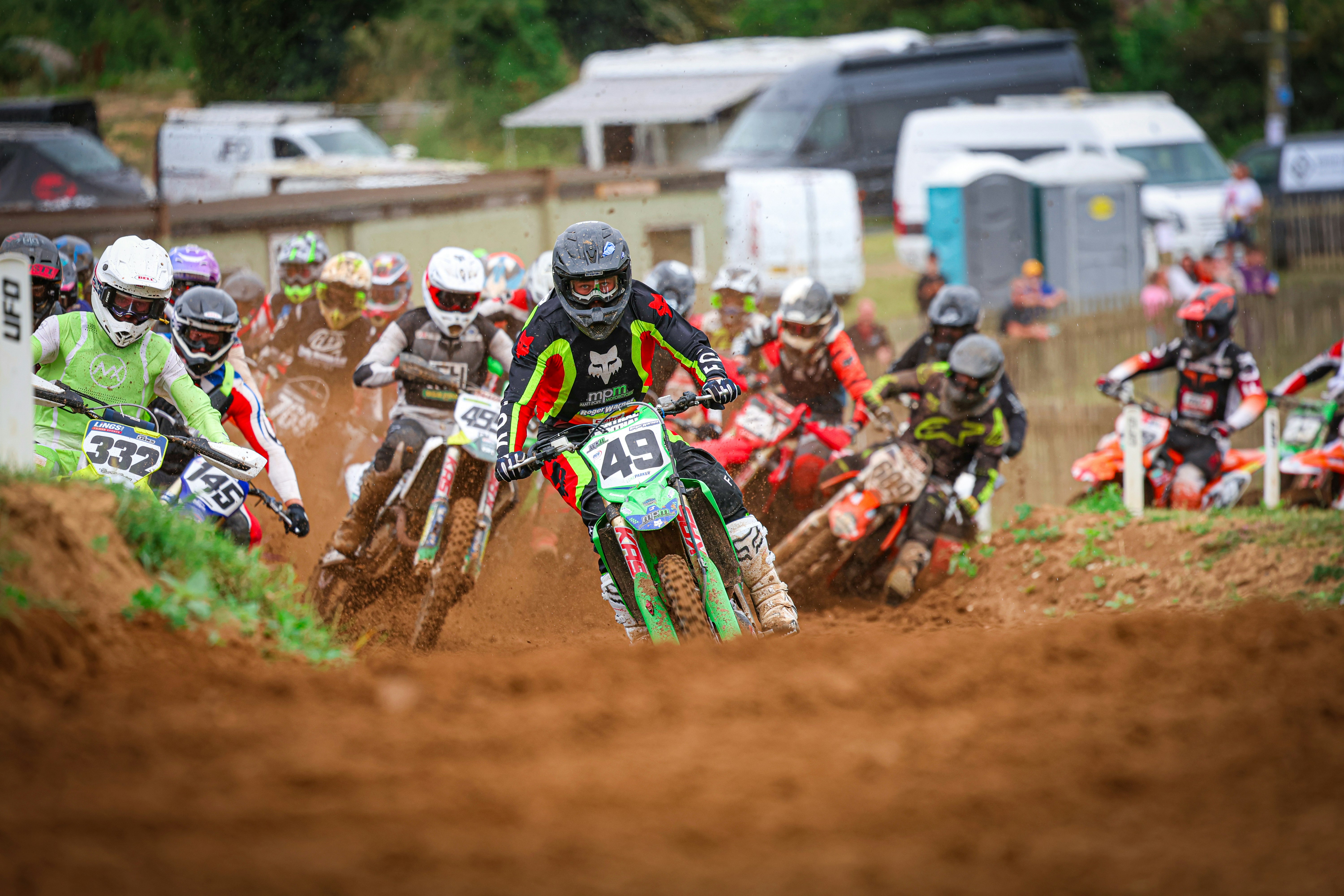 A group of people riding dirt bikes on a dirt track photo – Free ...