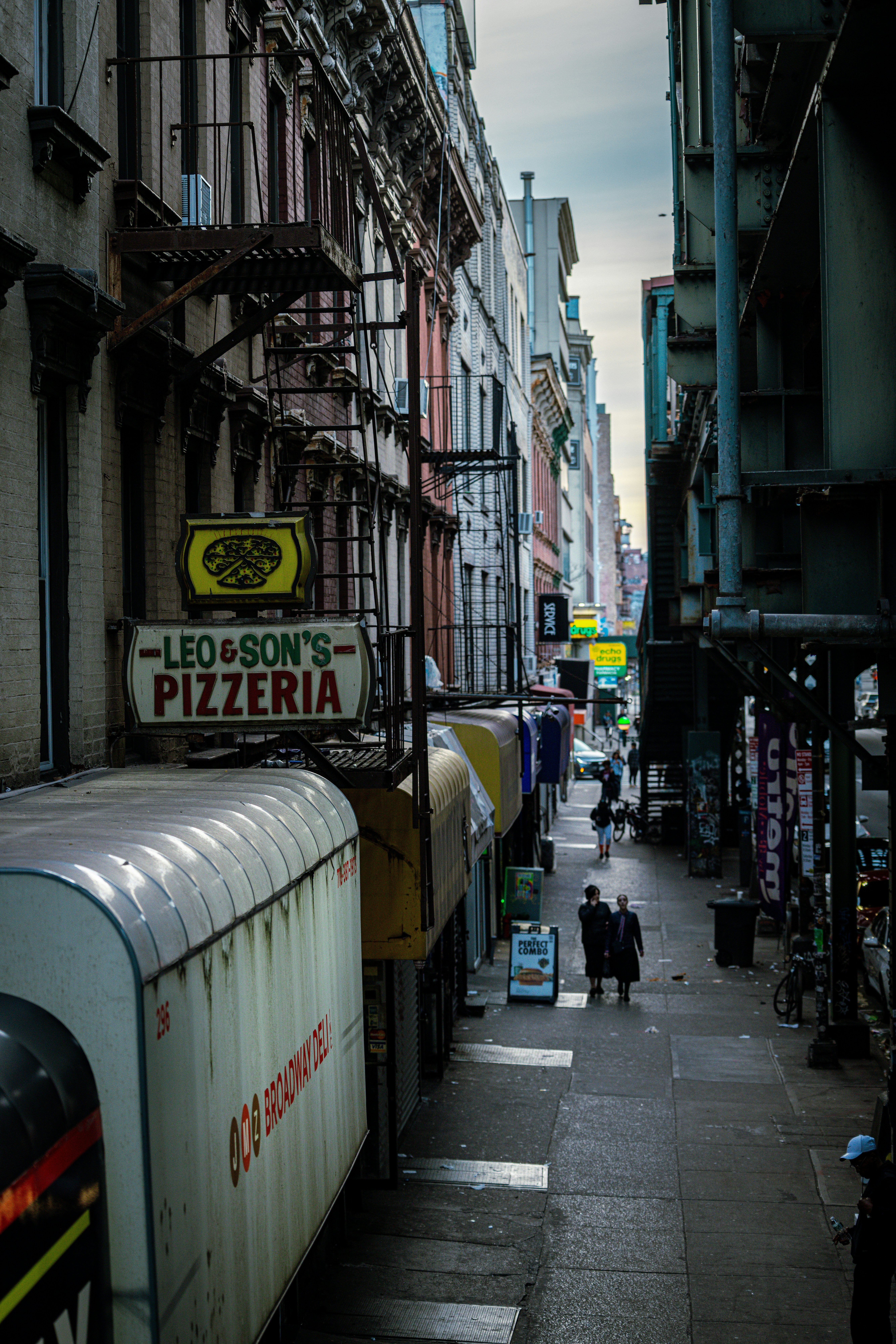 A narrow city street lined with tall buildings photo – Free Marcy ...