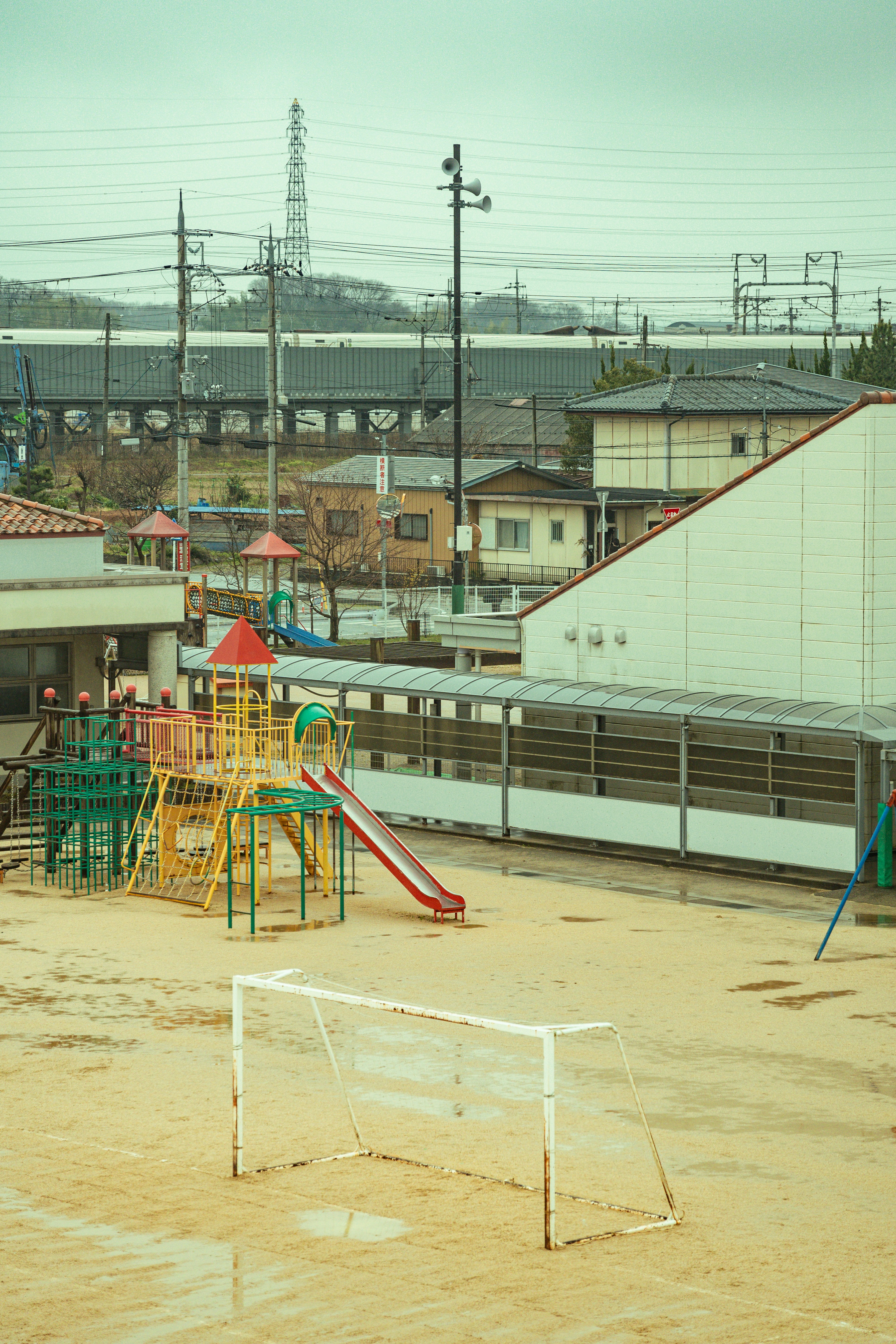 A playground with a soccer goal in the middle of it