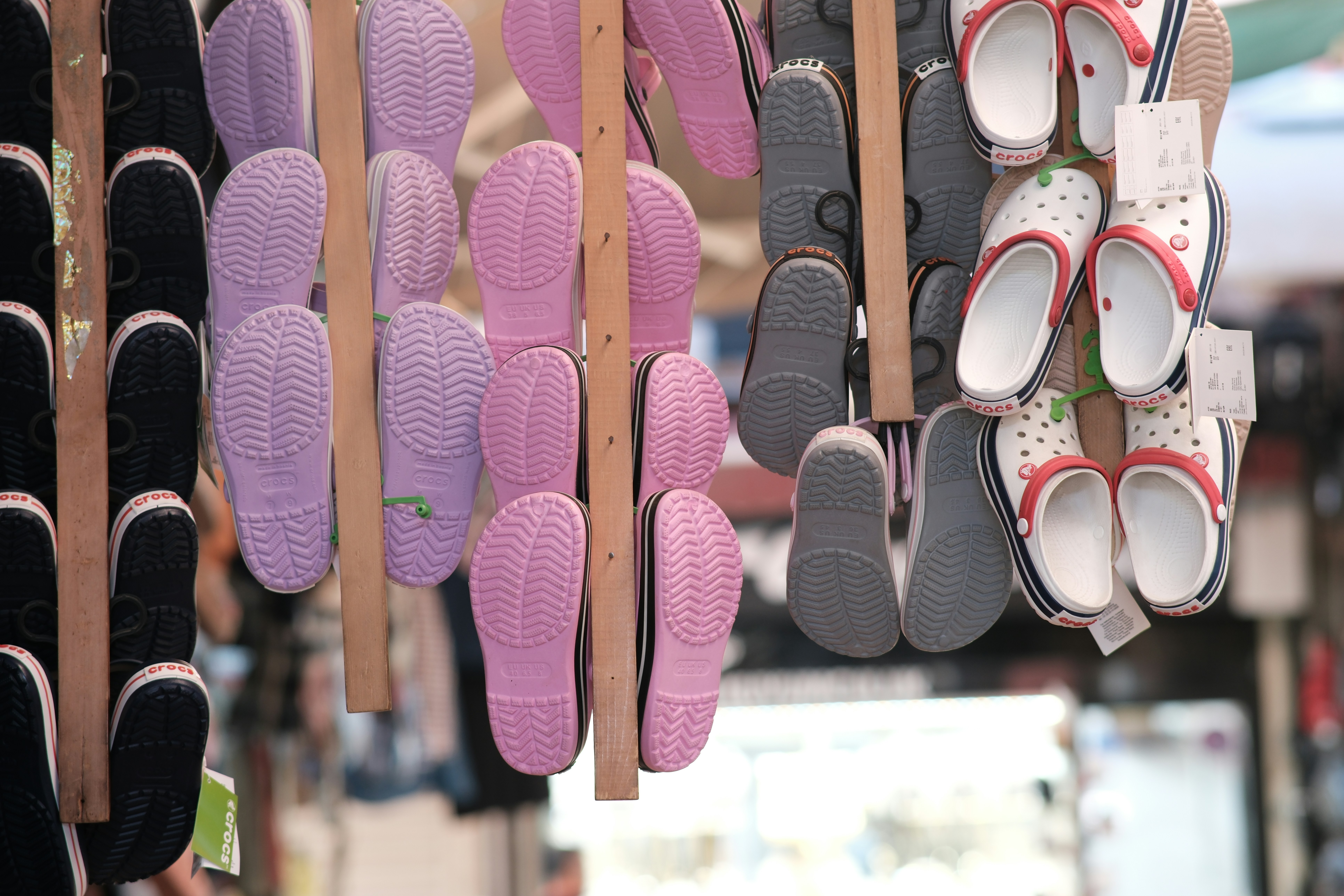 A bunch of shoes that are hanging up photo – Free Shop Image on Unsplash