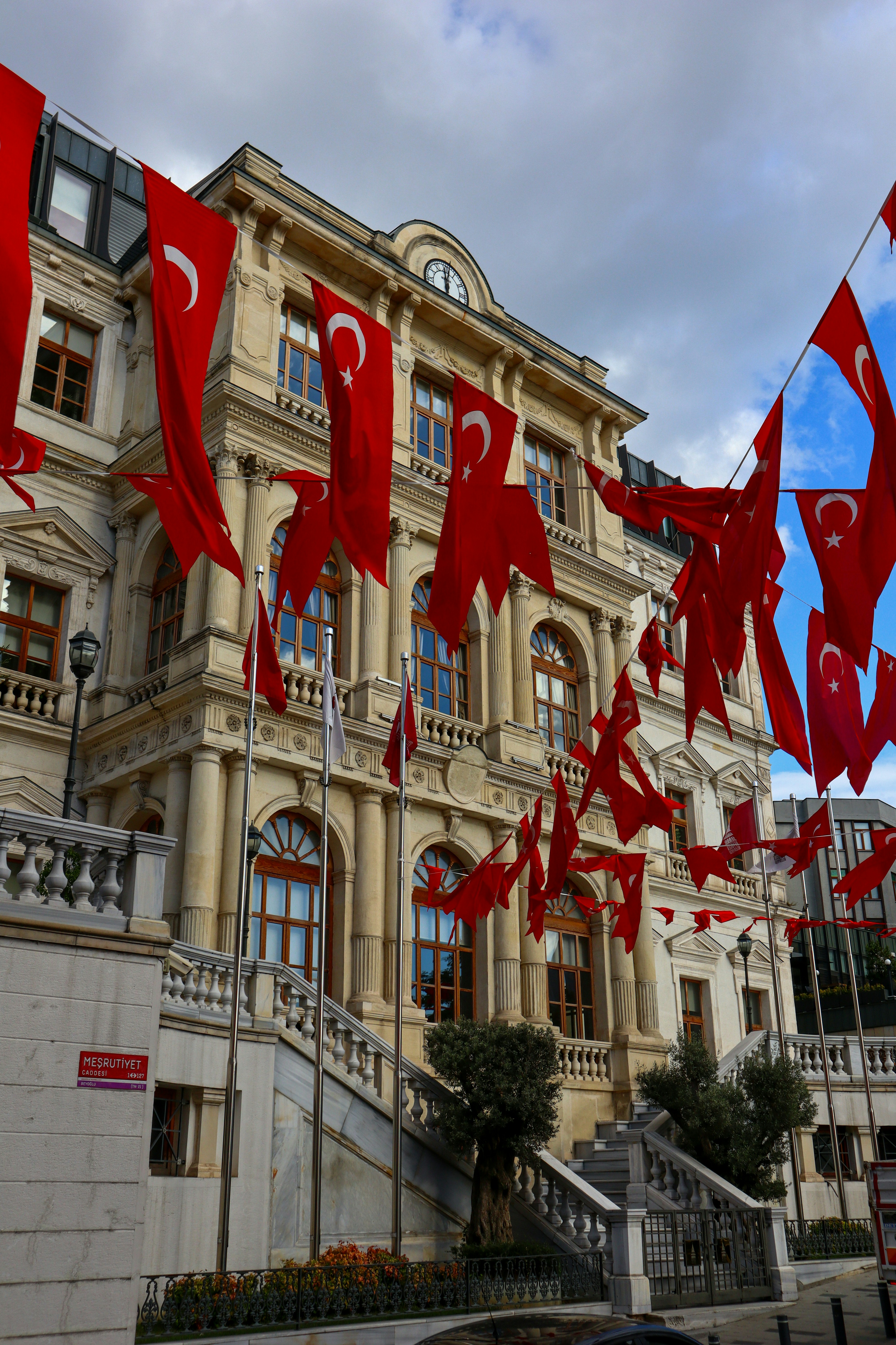 A large building with many red flags hanging from it's sides photo ...