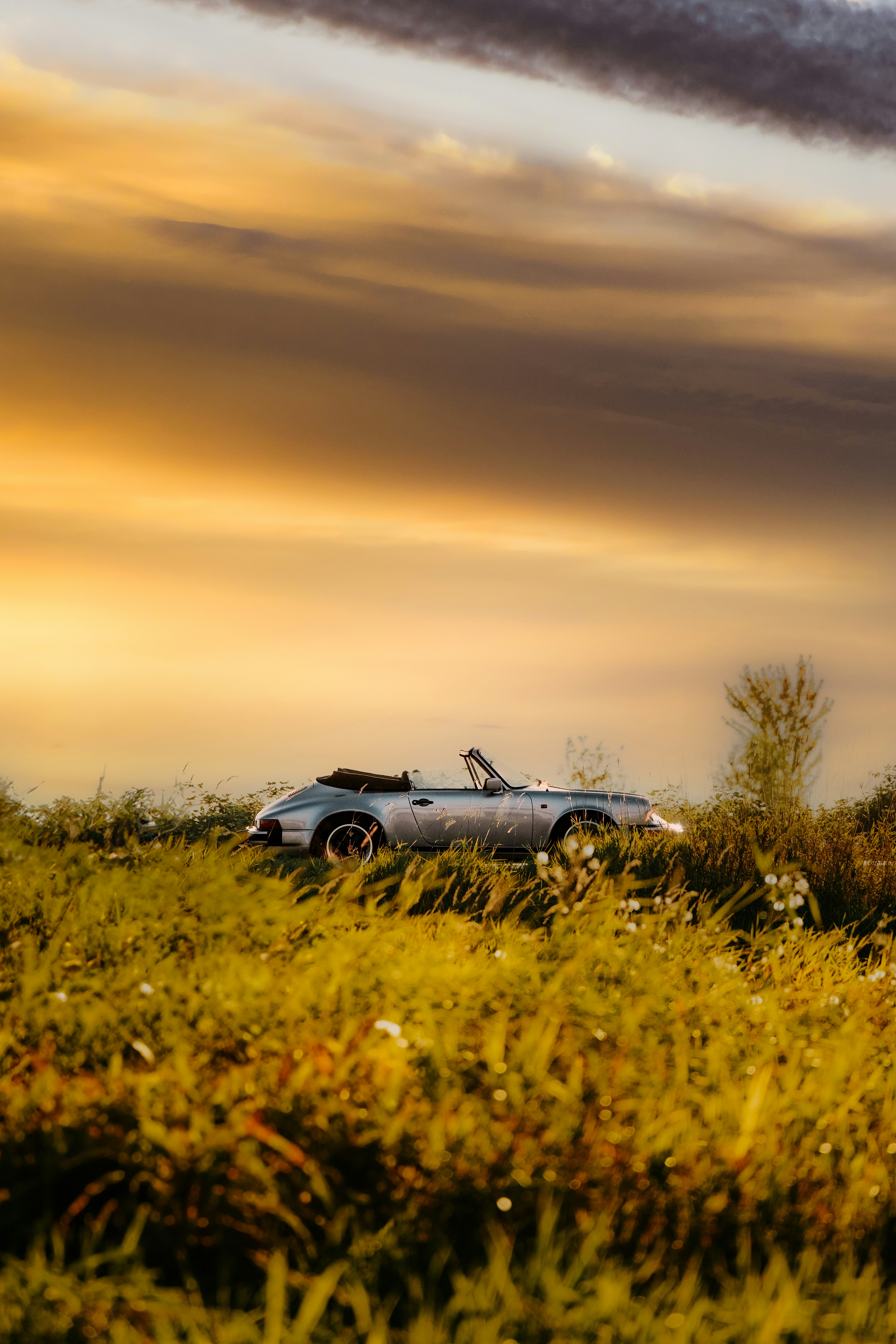 Prairie Sunset Runabout: A Silver Convertible at Golden Hour