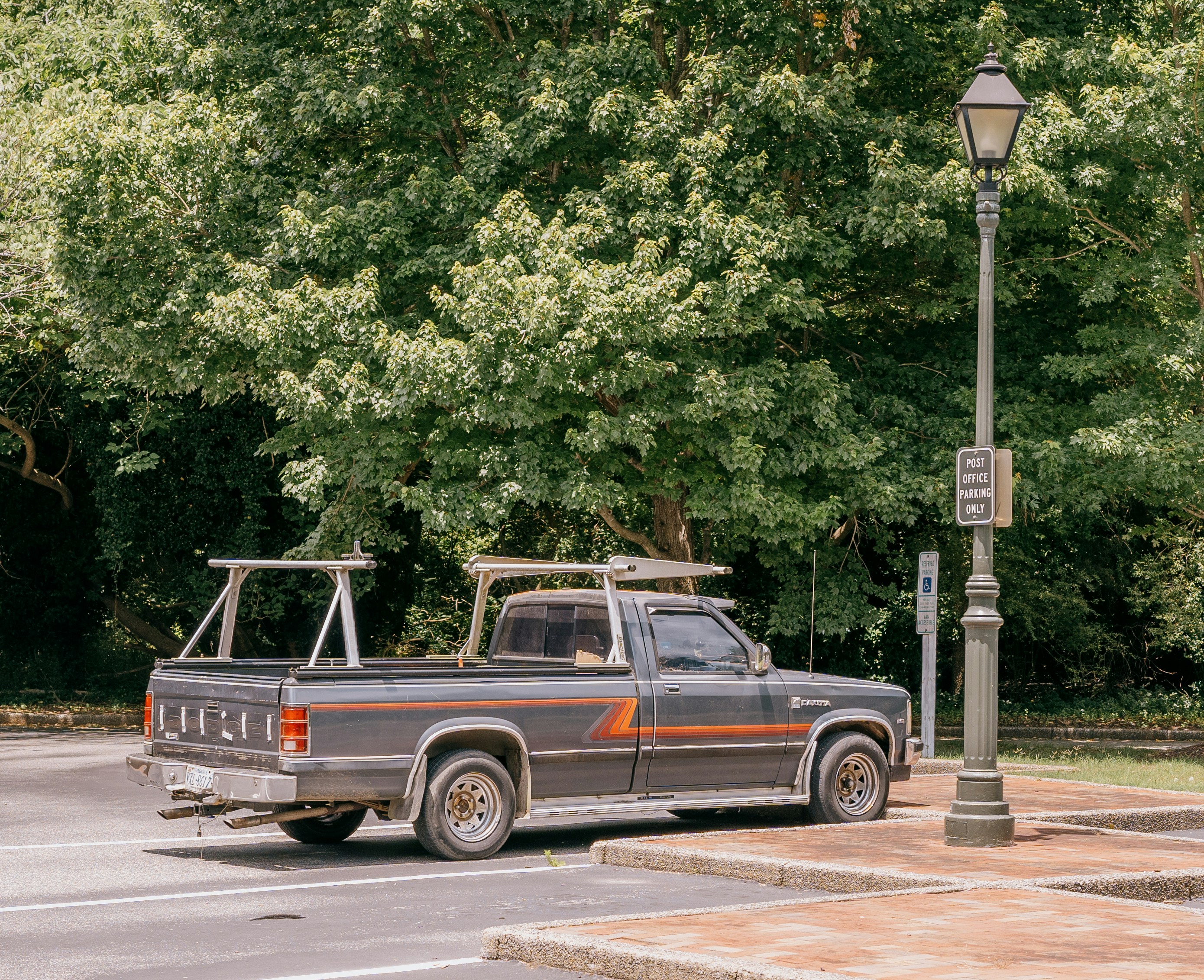 Patina Under the Oaks: A Weathered Pickup Resting in a Quiet Park Lot