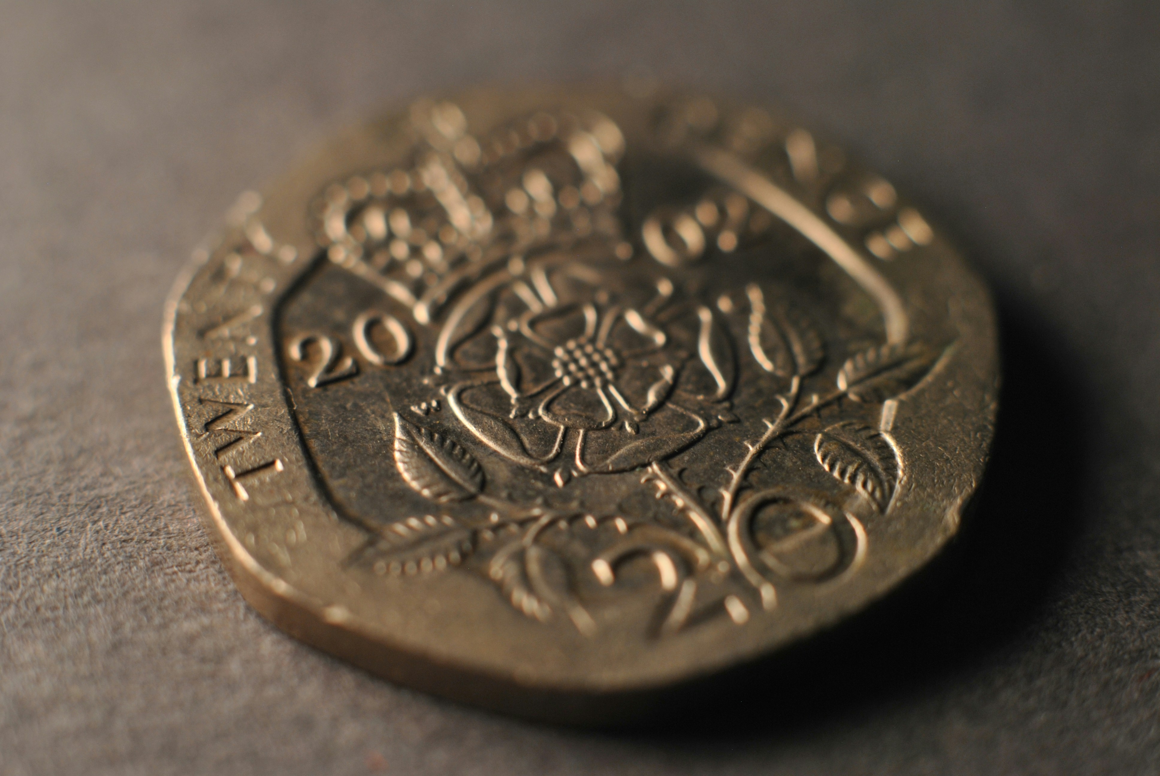 A close up of a coin on a table photo – Free Money coins Image on Unsplash