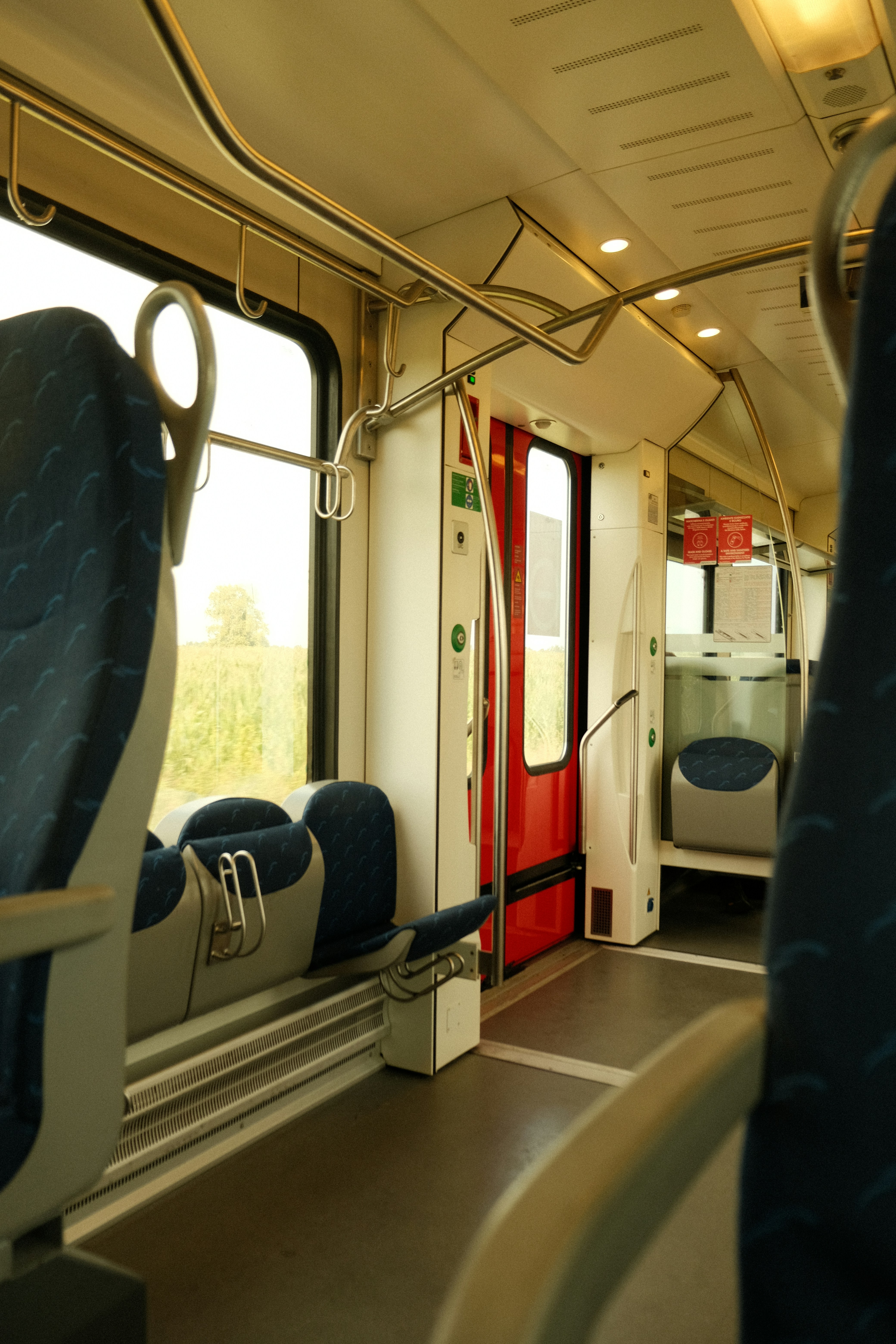 The inside of a train with blue seats and a red door photo – Free Train ...