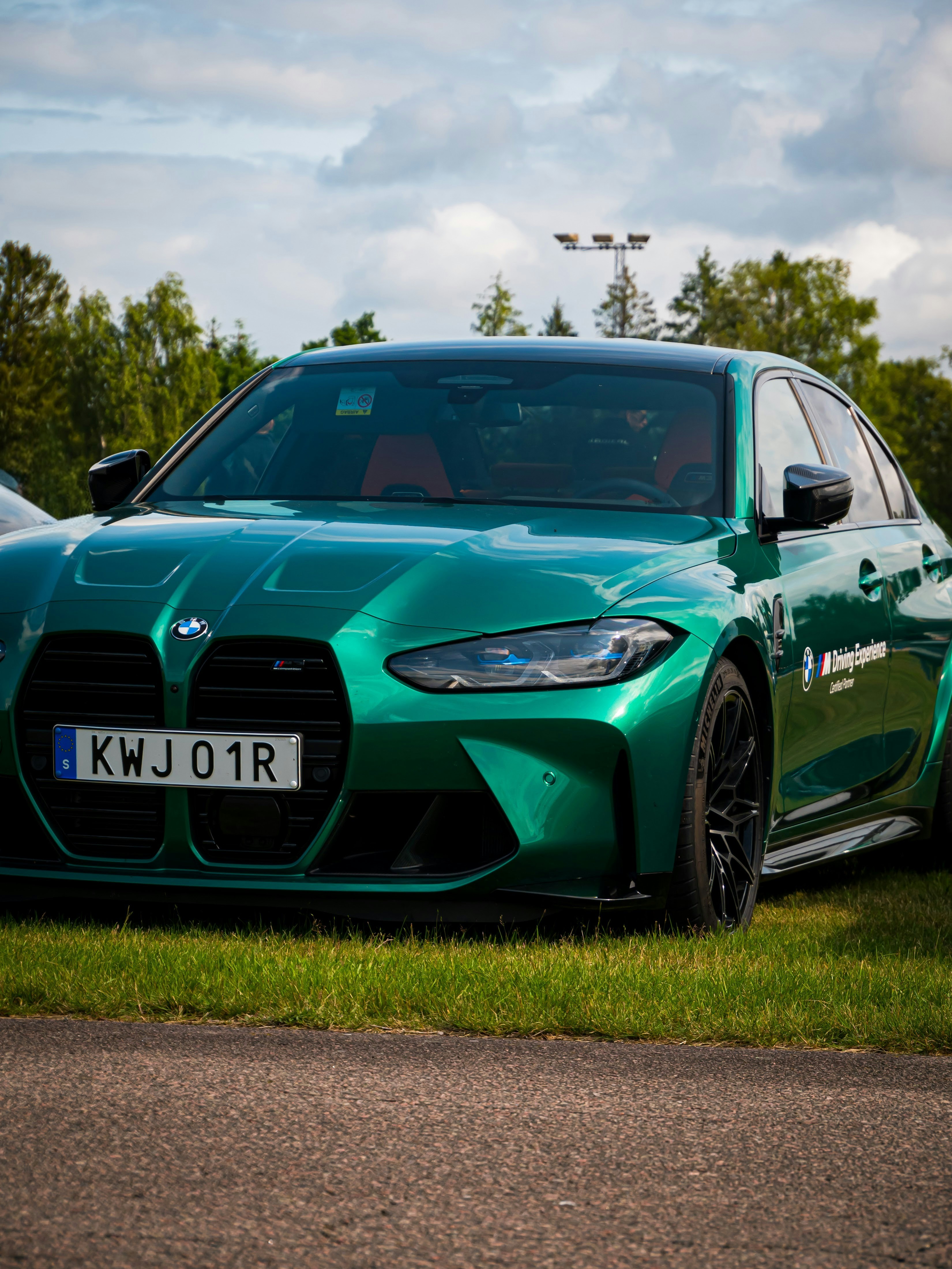 Emerald Stance: Front-Quarter BMW Under a Summer Sky