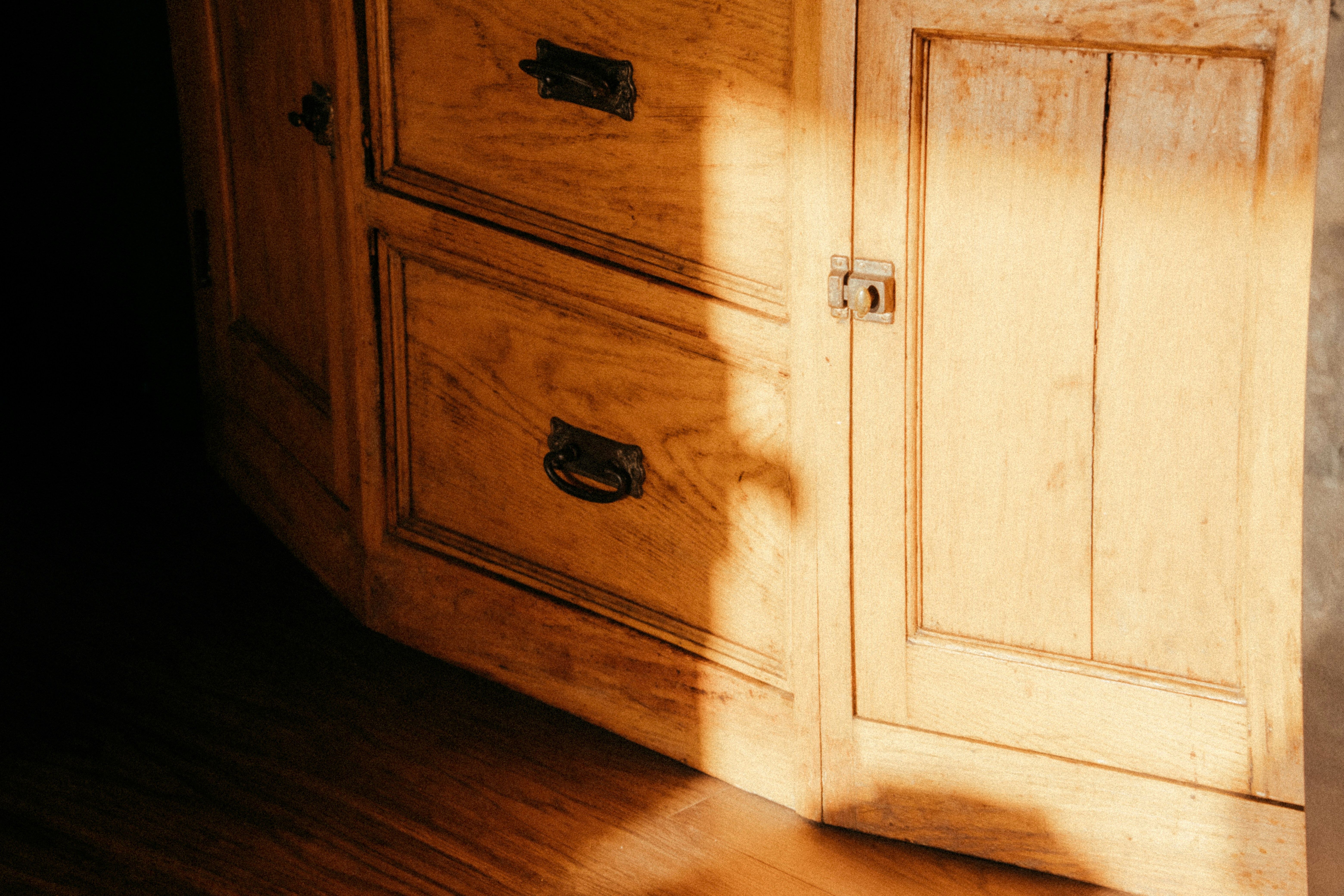 Amber Ray on a Weathered Dresser: Geometry of Light and Wood