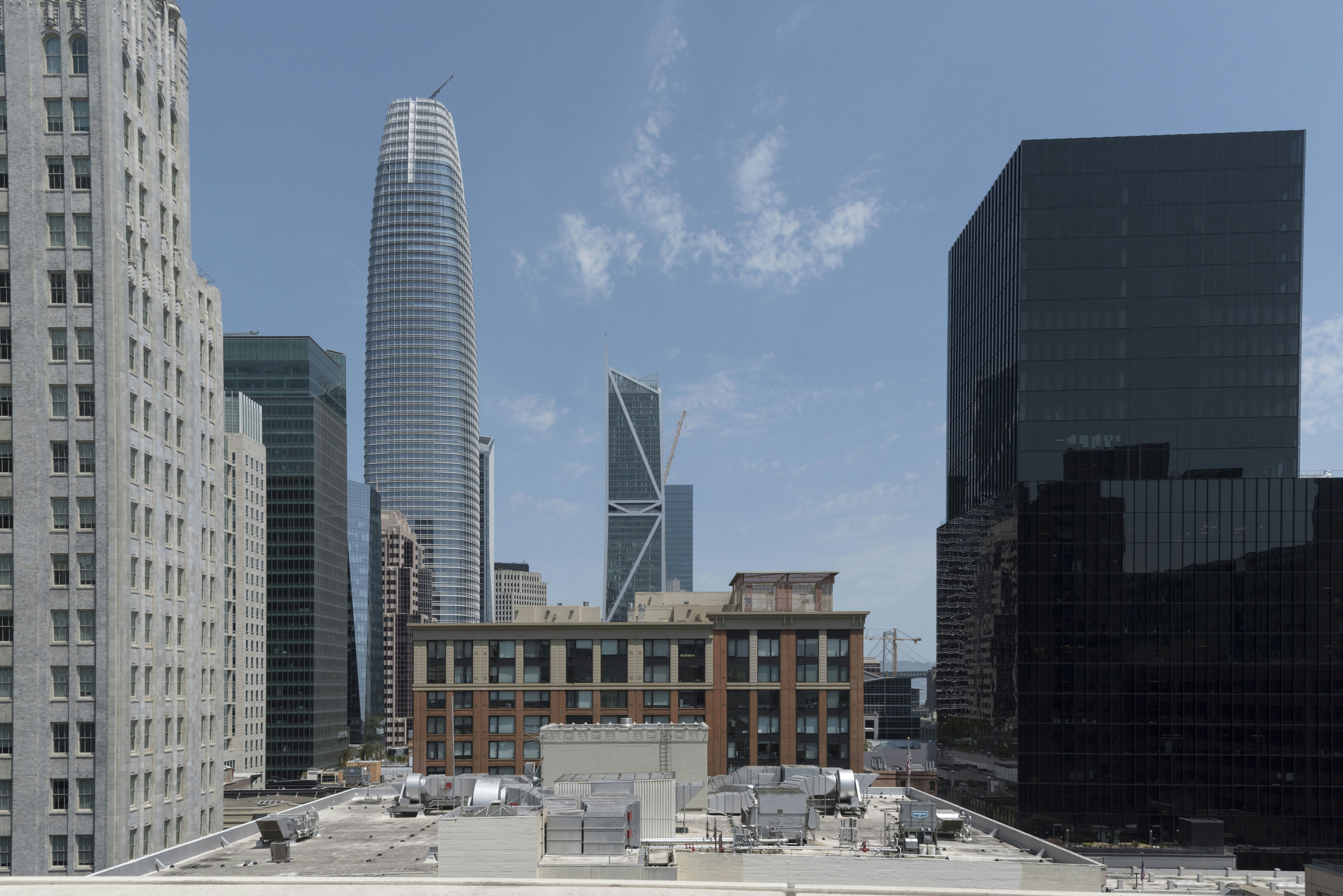 Rooftop Horizon: Concrete Giants Framed by a Clear Downtown Sky