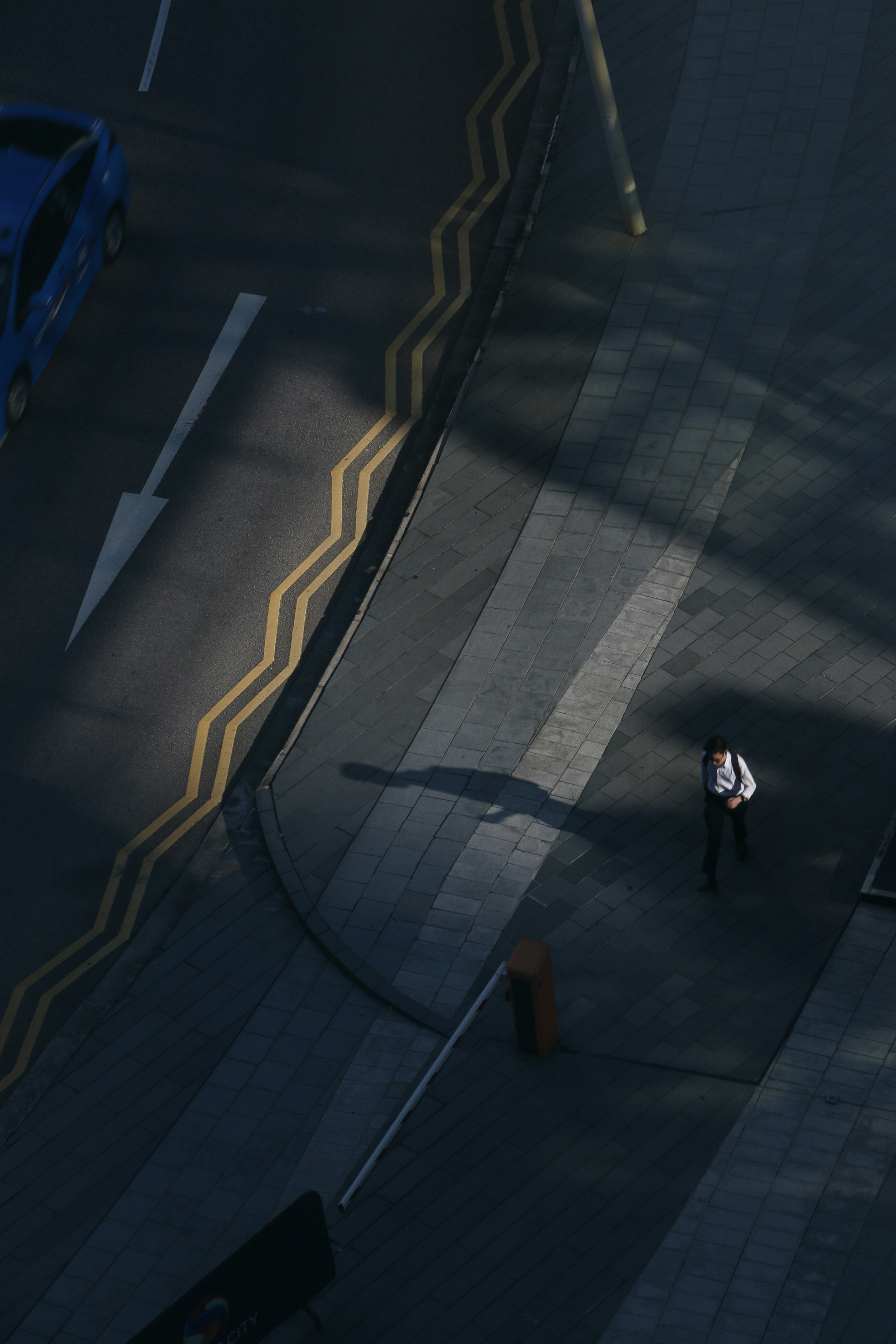 An aerial view of a person walking down a streetMilin John