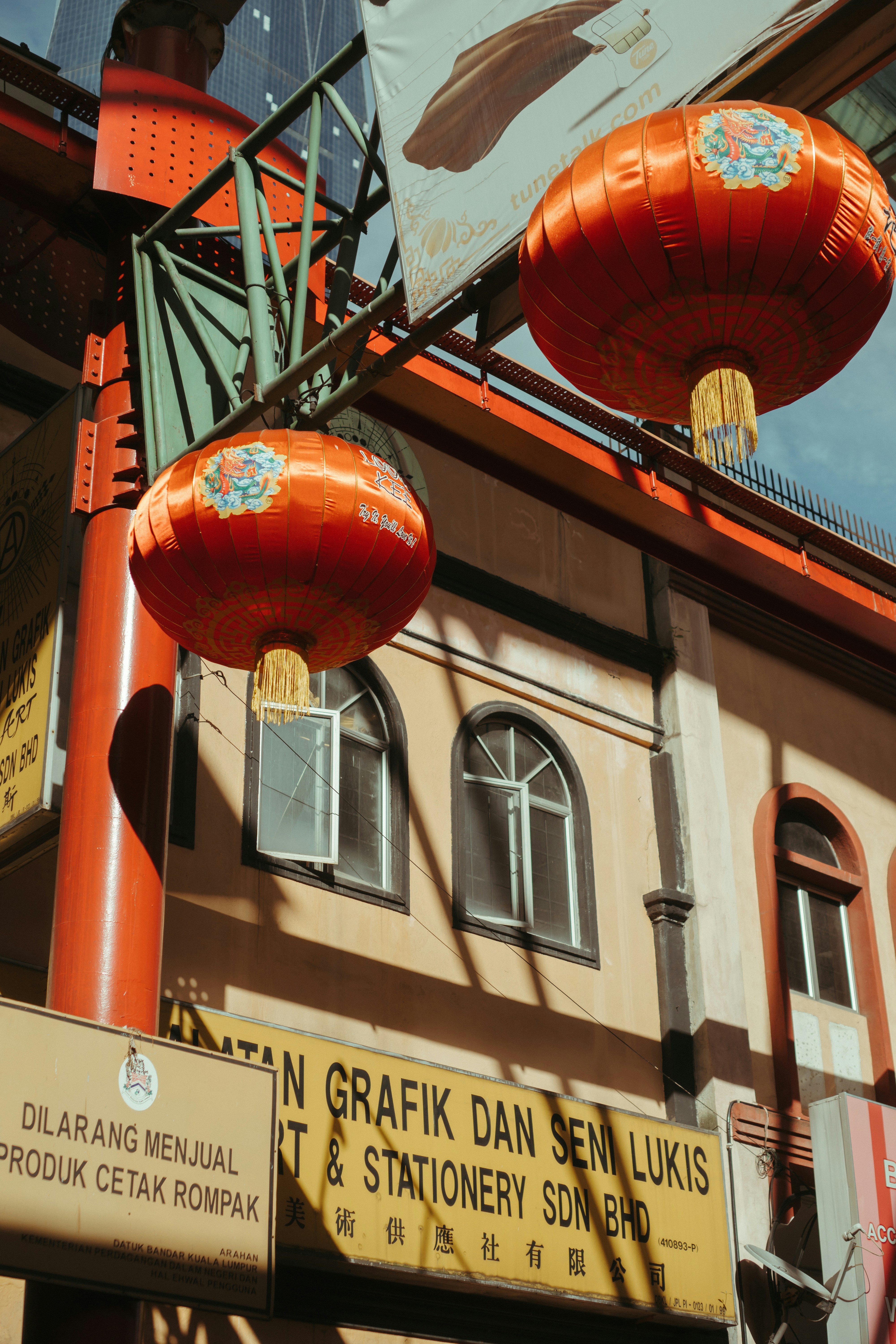 Crimson Lanterns Over a Sunlit Chinatown Market Facade