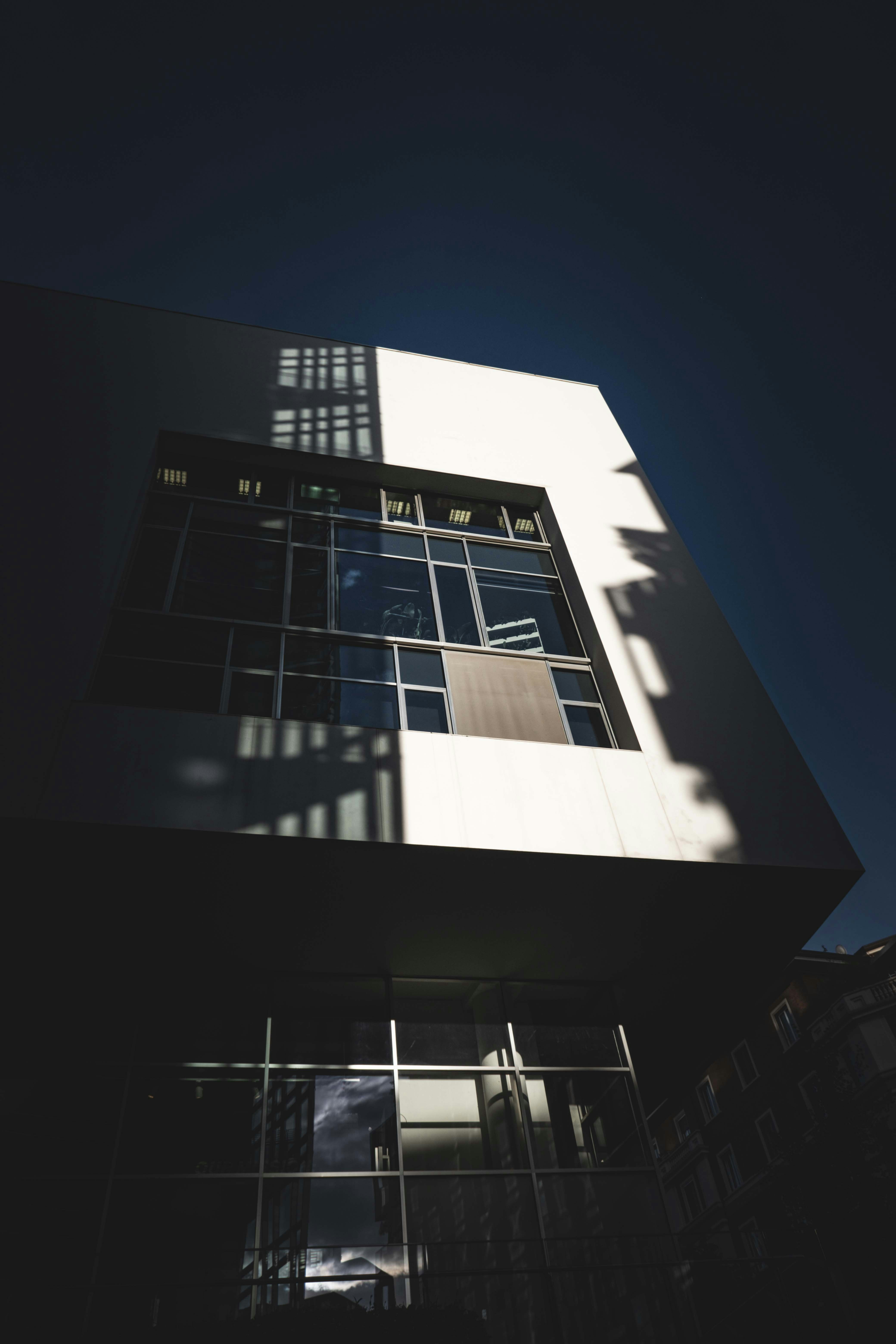 A tall white building with lots of windows photo – Free Building Image ...