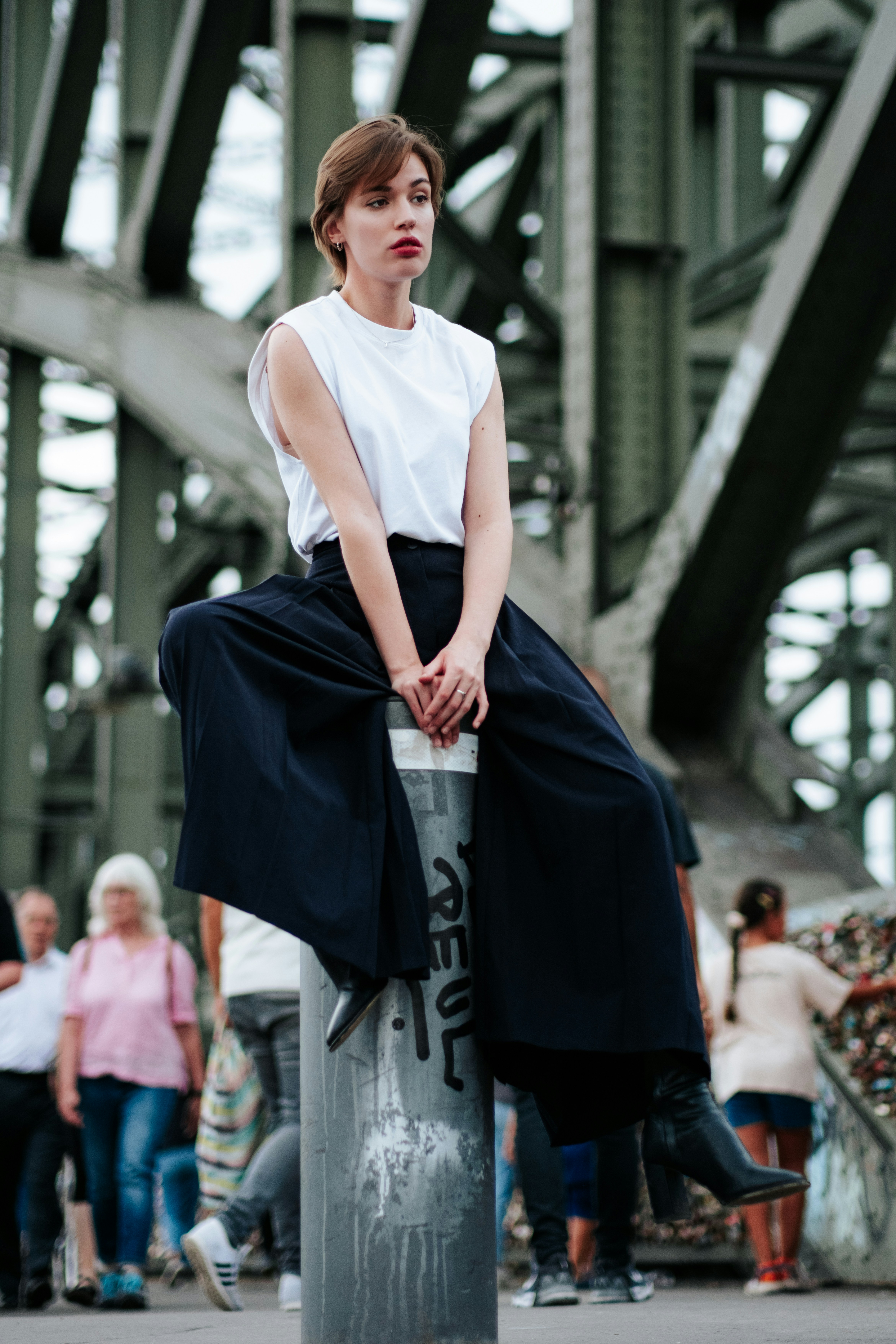 Poise on a Steel Column: A Fashion Moment Under the City Bridge