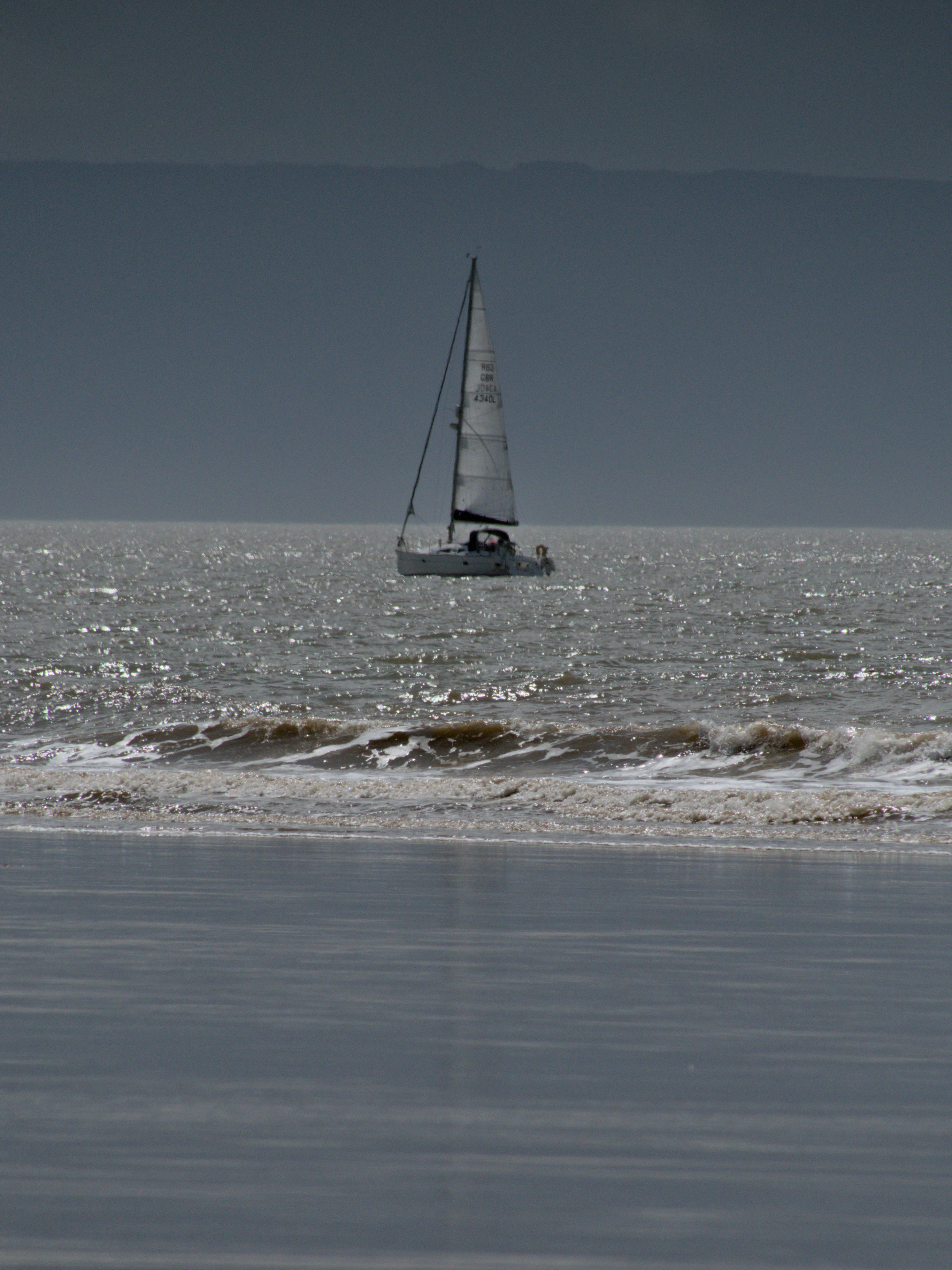 A sailboat in the middle of the ocean photo – Free Porthcawl Image on ...