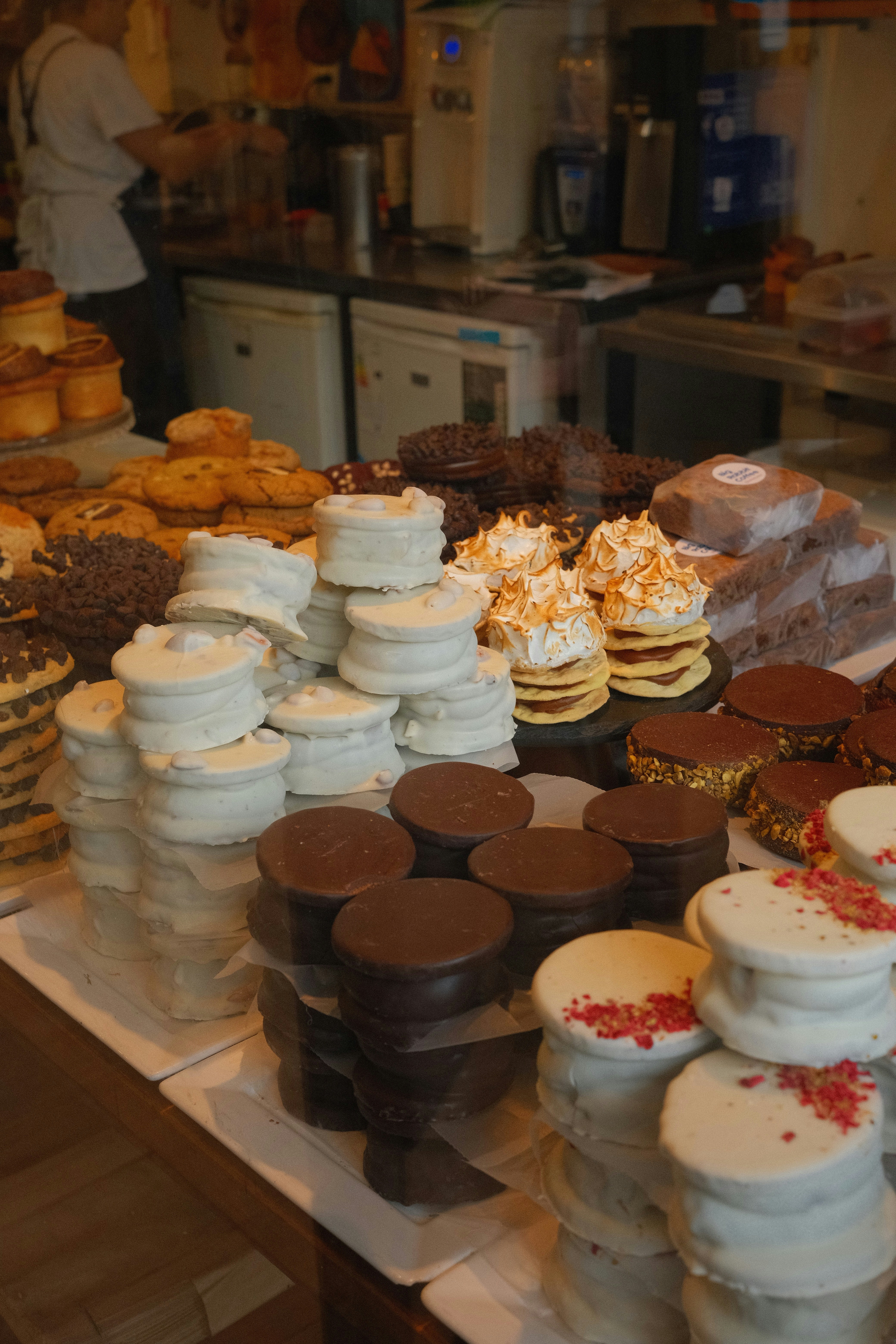 A display case filled with lots of different types of cakes photo ...