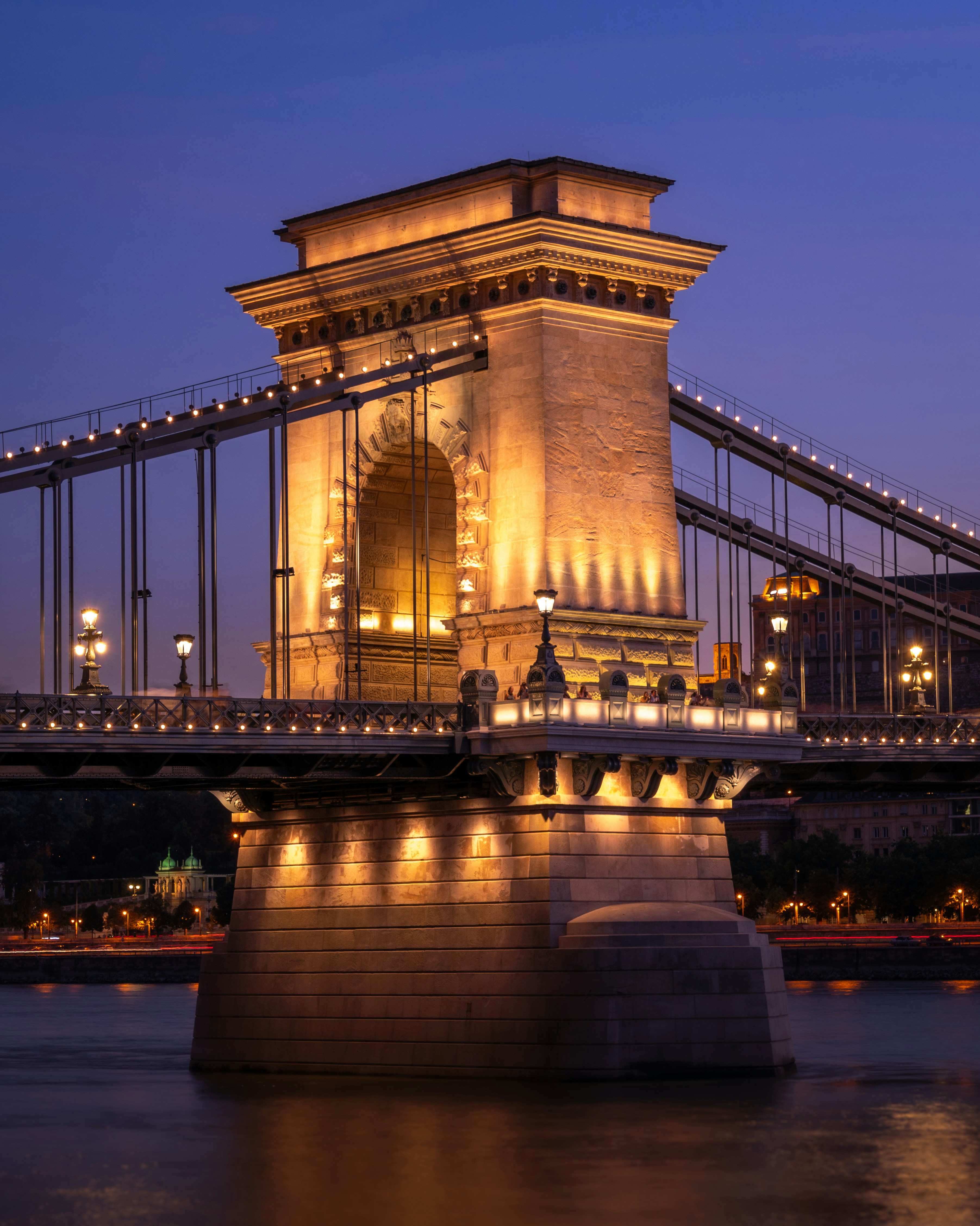 The Széchenyi Chain Bridge is a chain bridge that spans the River Danube between Buda and Pest, the western and eastern sides of Budapest, the capital of Hungary.