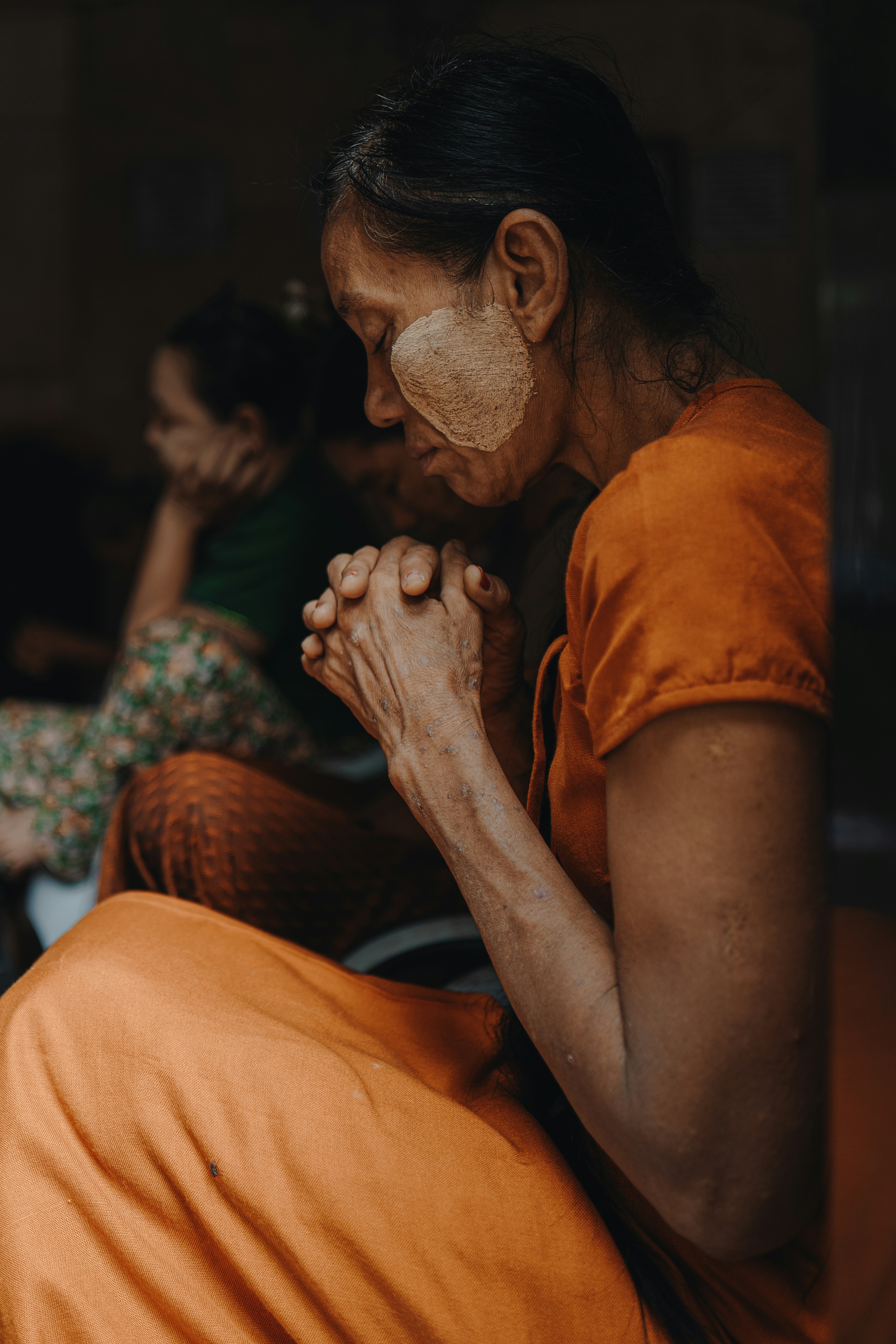 Burmese woman praying in small local church
