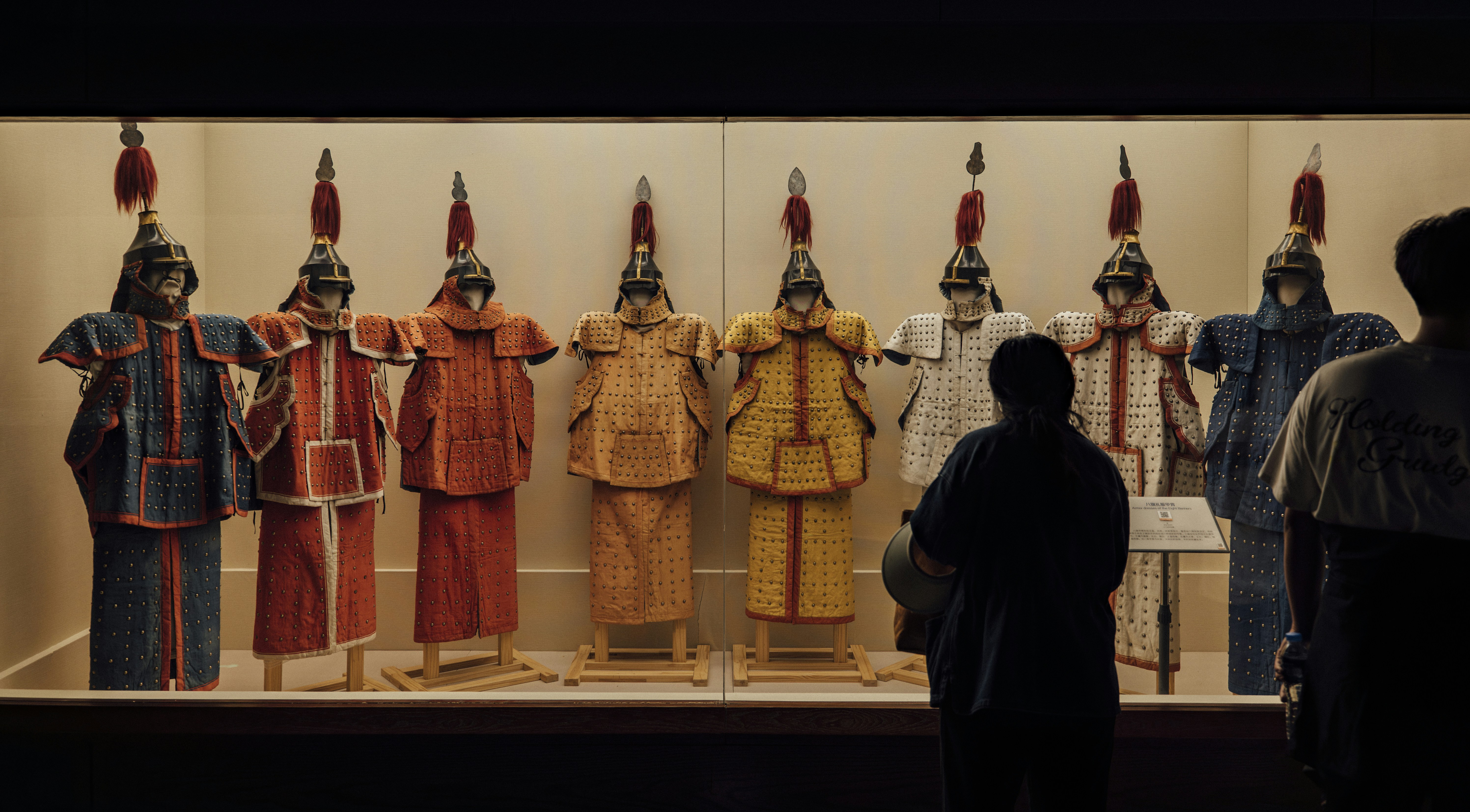 Guardians in Silk: Ceremonial armors line a storefront window