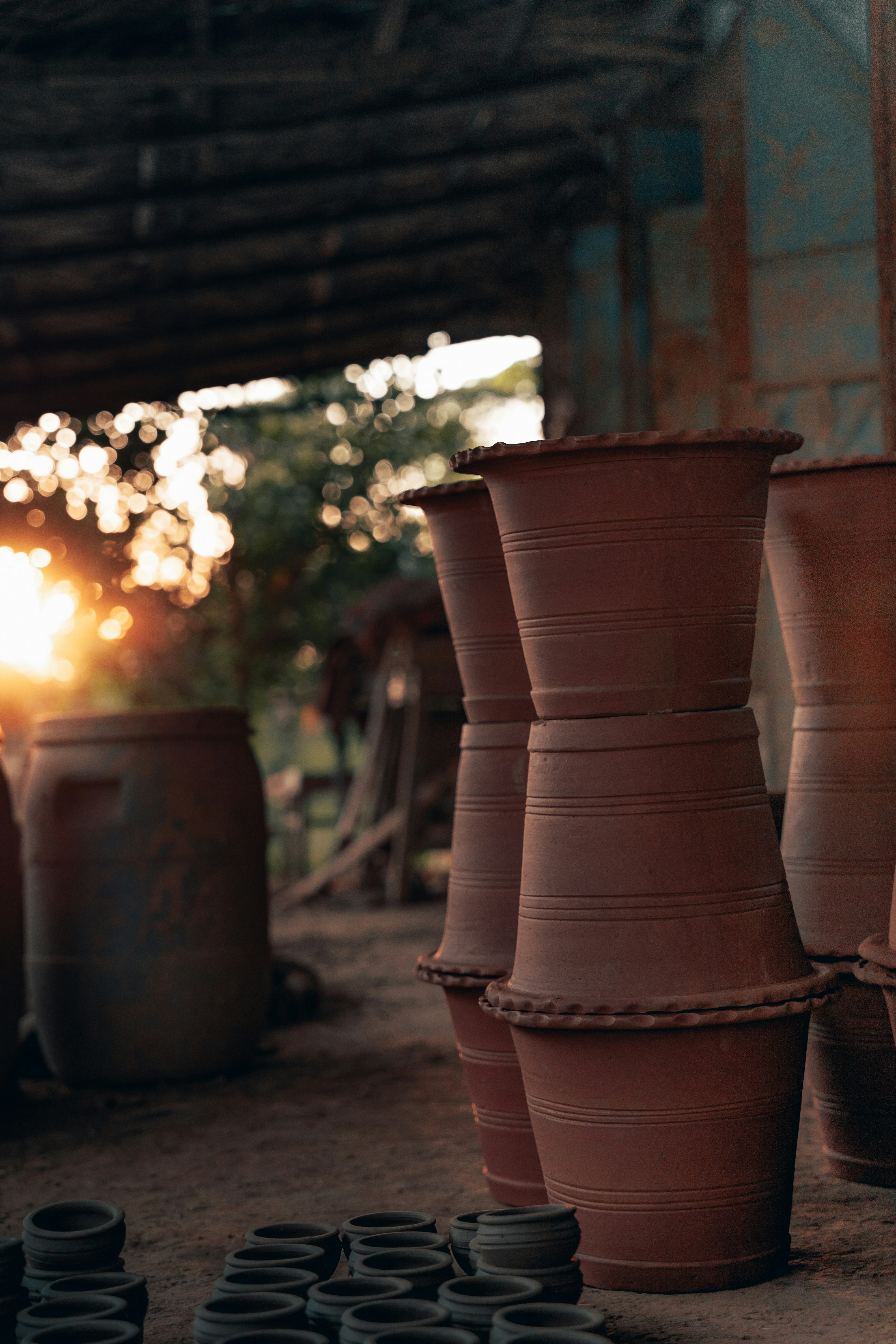 The Quiet Stack: Geometry and Sunset Light on Terracotta Vessels