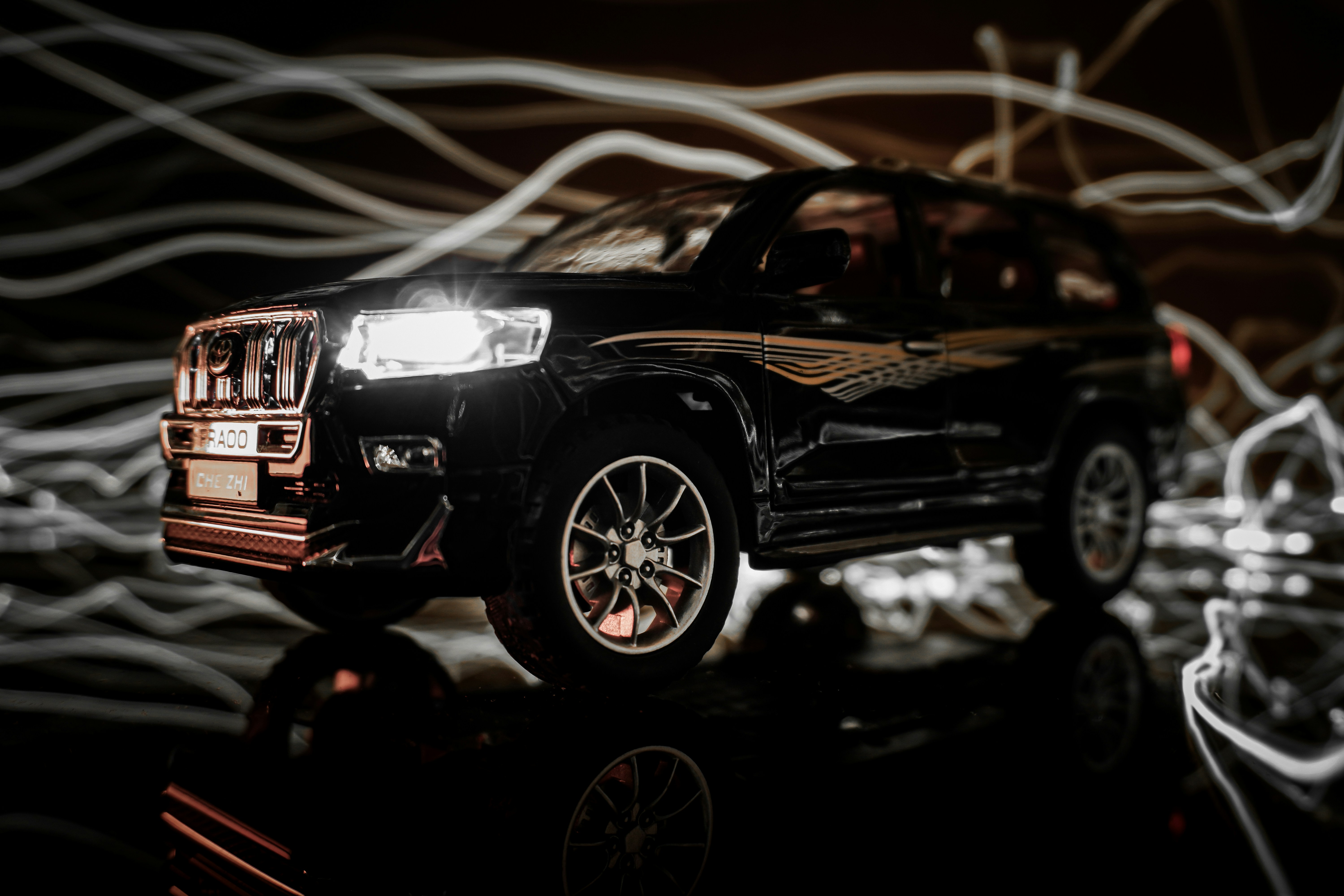 Nocturnal Run: Neon Whorls Embrace a Glossy Toy SUV