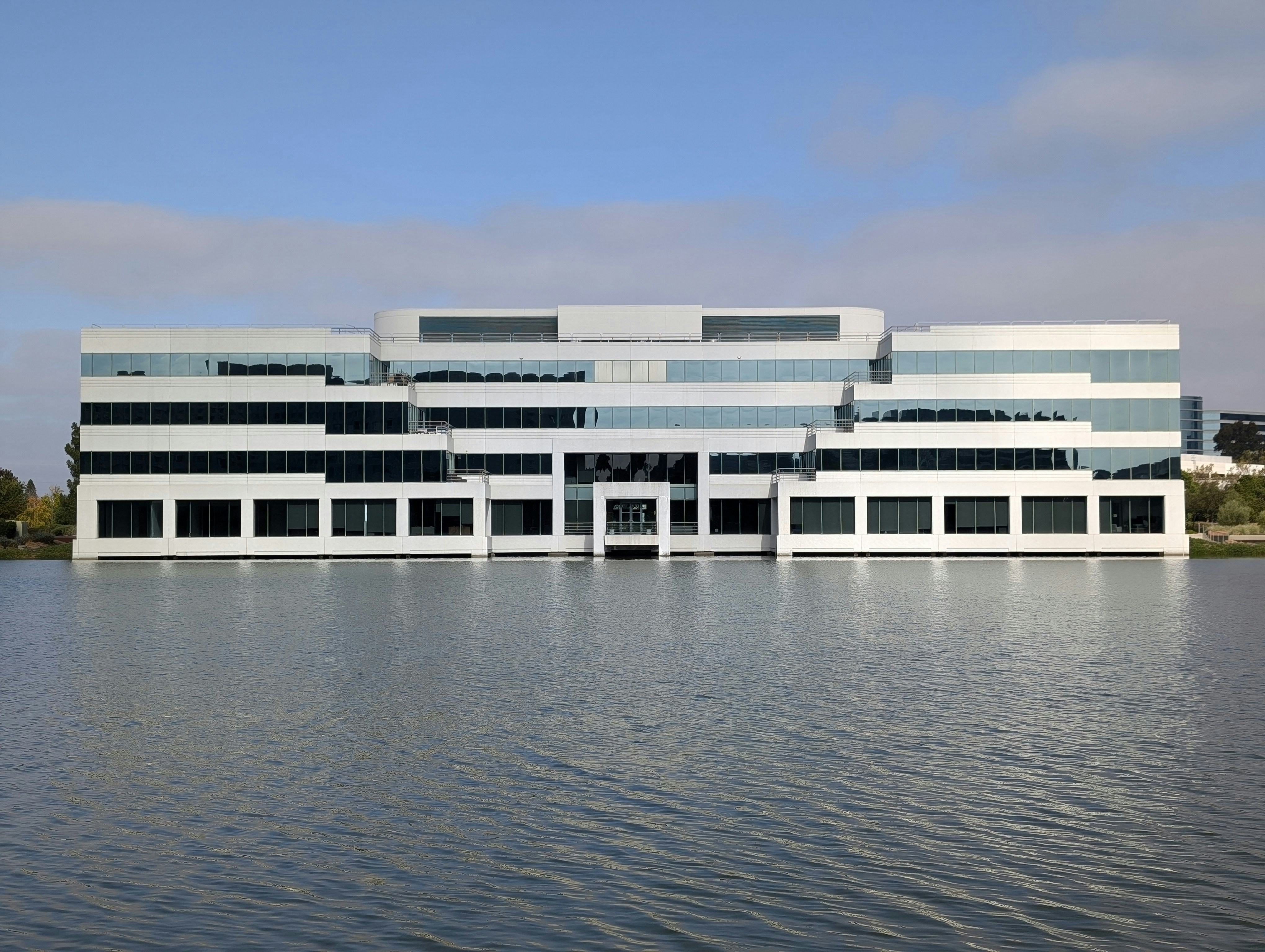 A large building sitting next to a body of water photo – Free Building ...