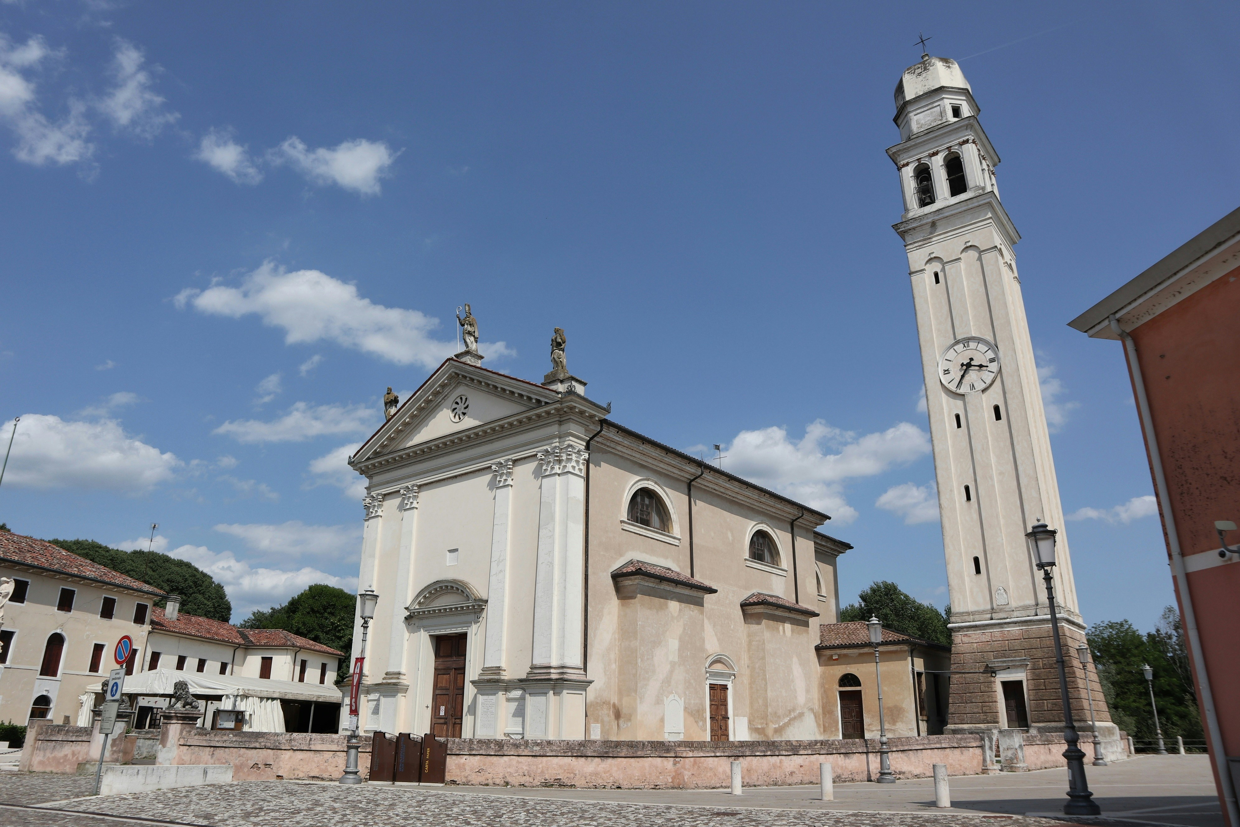 A large white building with a clock tower in the background photo ...