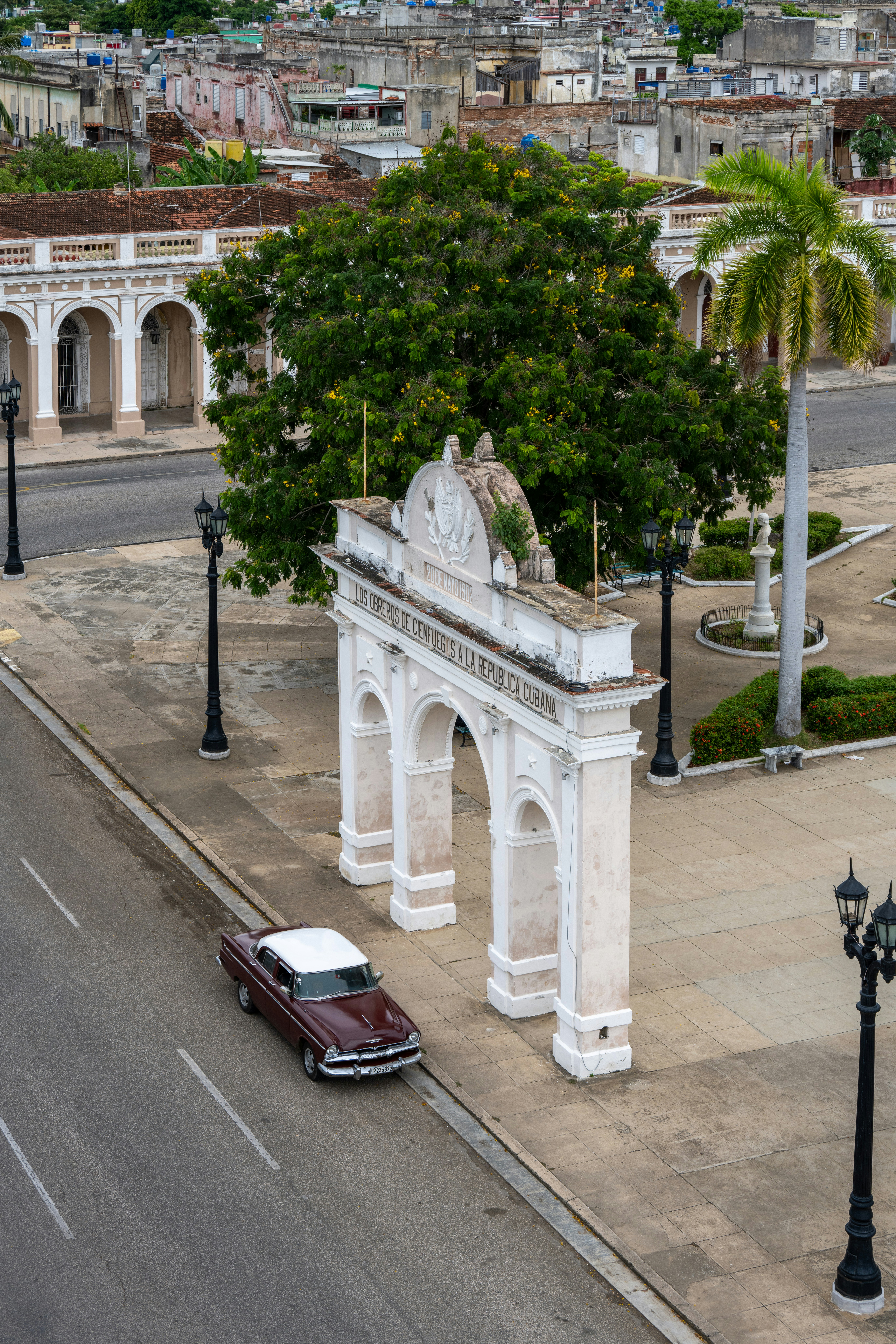 Archway Twilight: A Vintage Buick on a Palm-lined Cuban Street