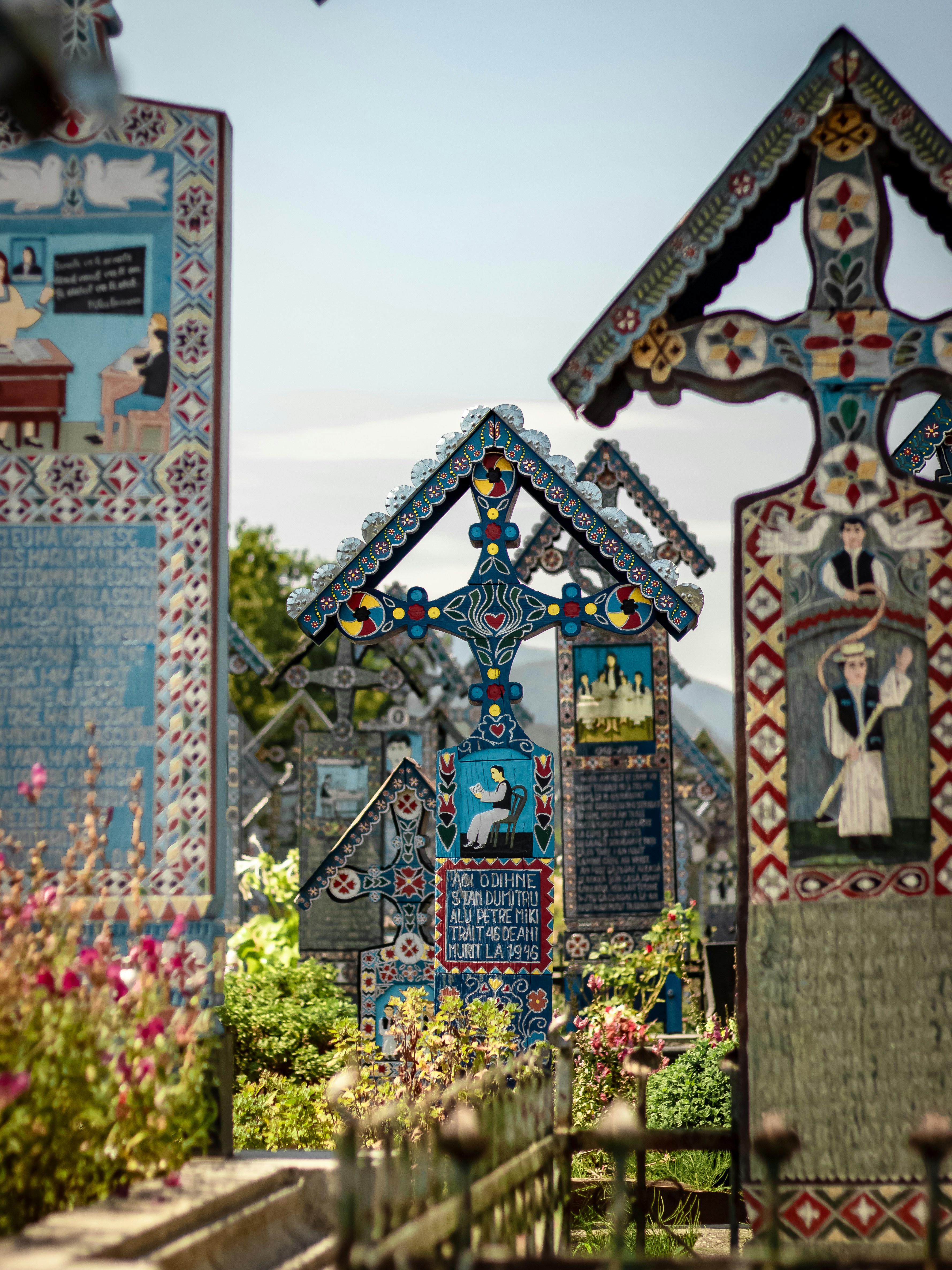 A group of colorfully decorated buildings with a fence in front of them ...