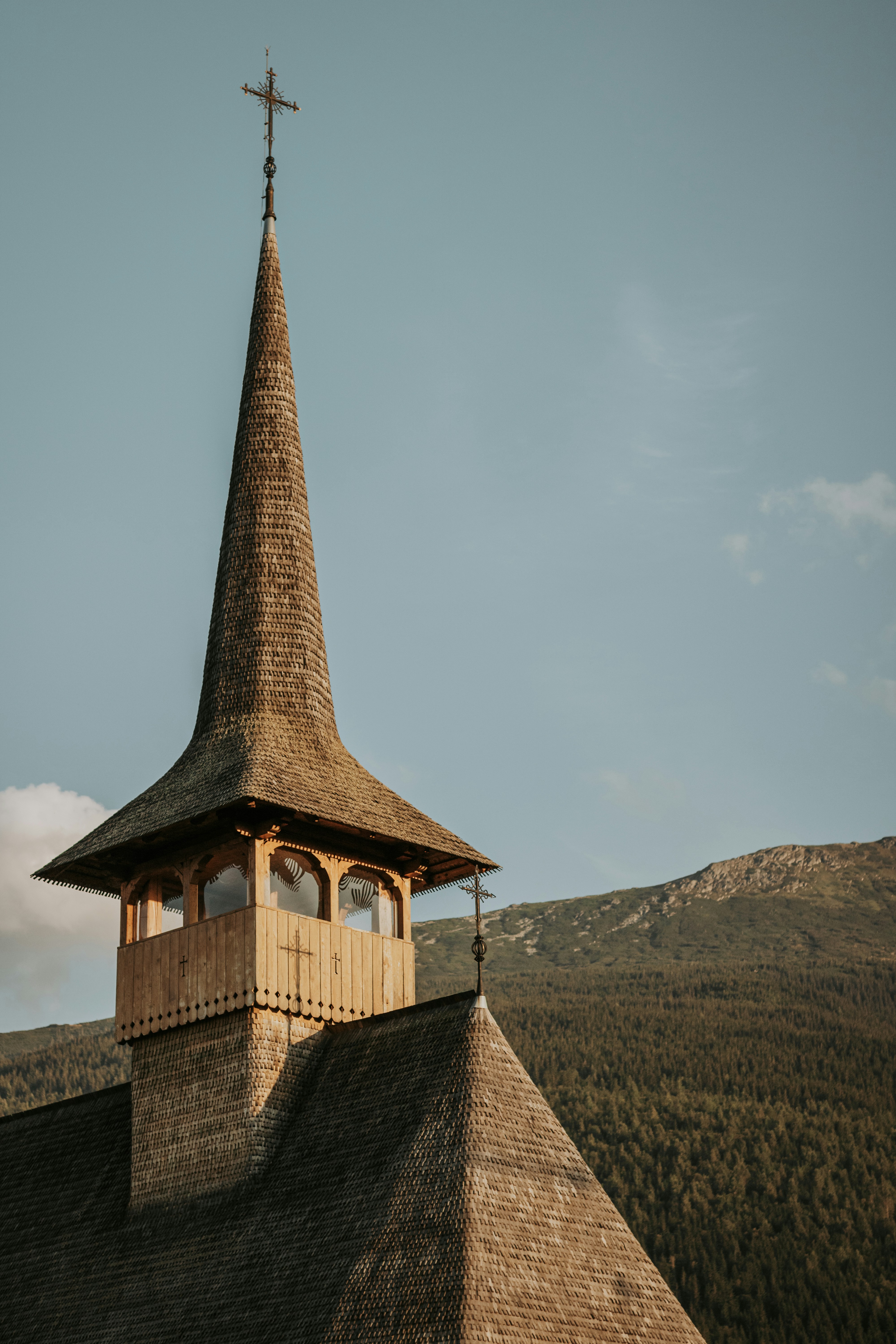 Timber Spire of an Alpine Chapel Reaching Toward the Sky