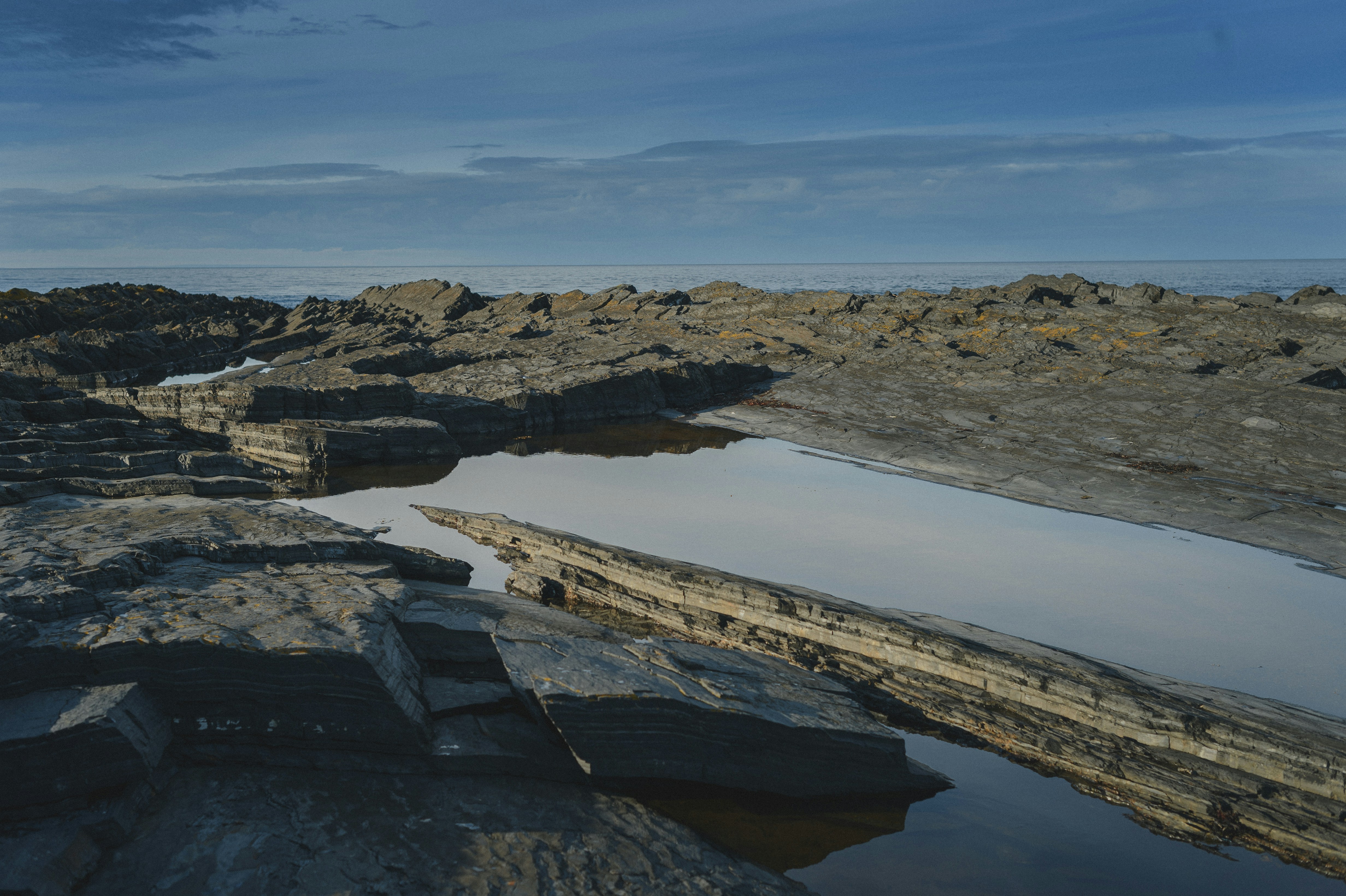 A large body of water surrounded by rocks photo – Free Russia Image on ...
