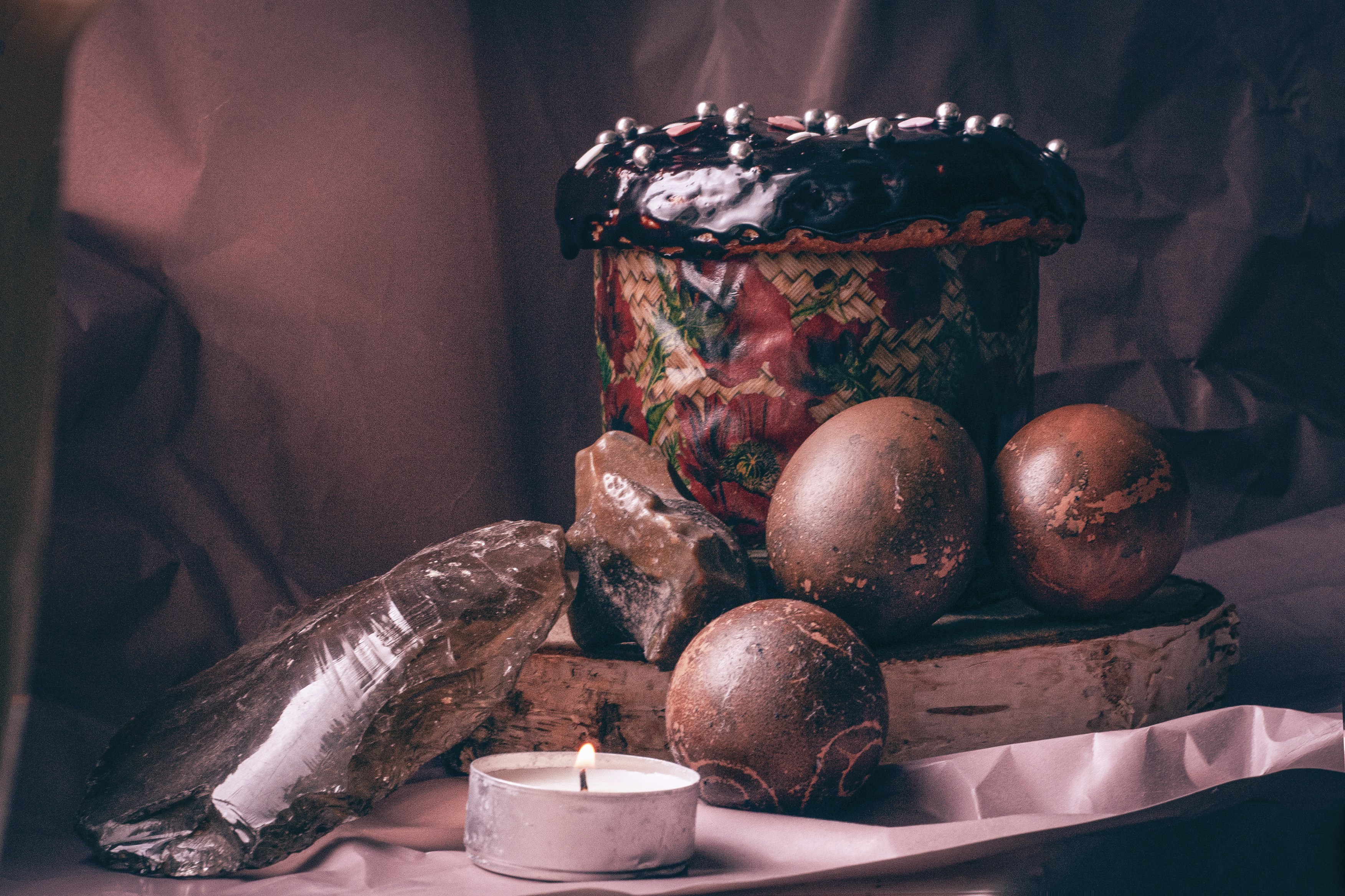 Amber Quiet: Candlelit Still Life with Decorative Jar and Earthy Orbs