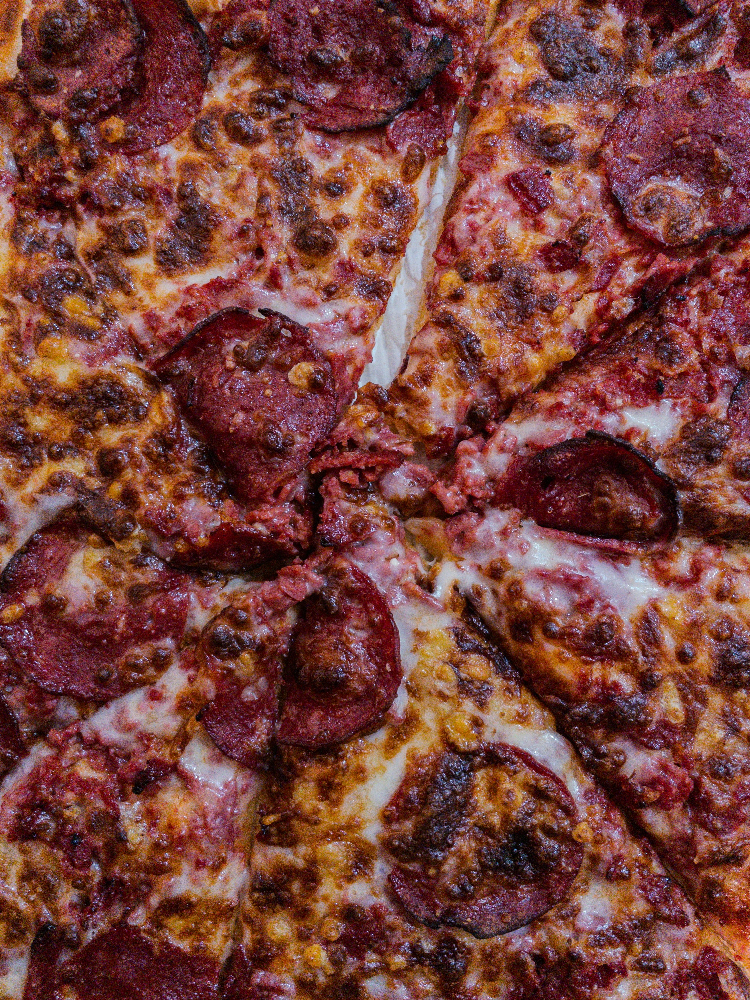 A close up of a pepperoni pizza on a table photo – Free Food Image on ...
