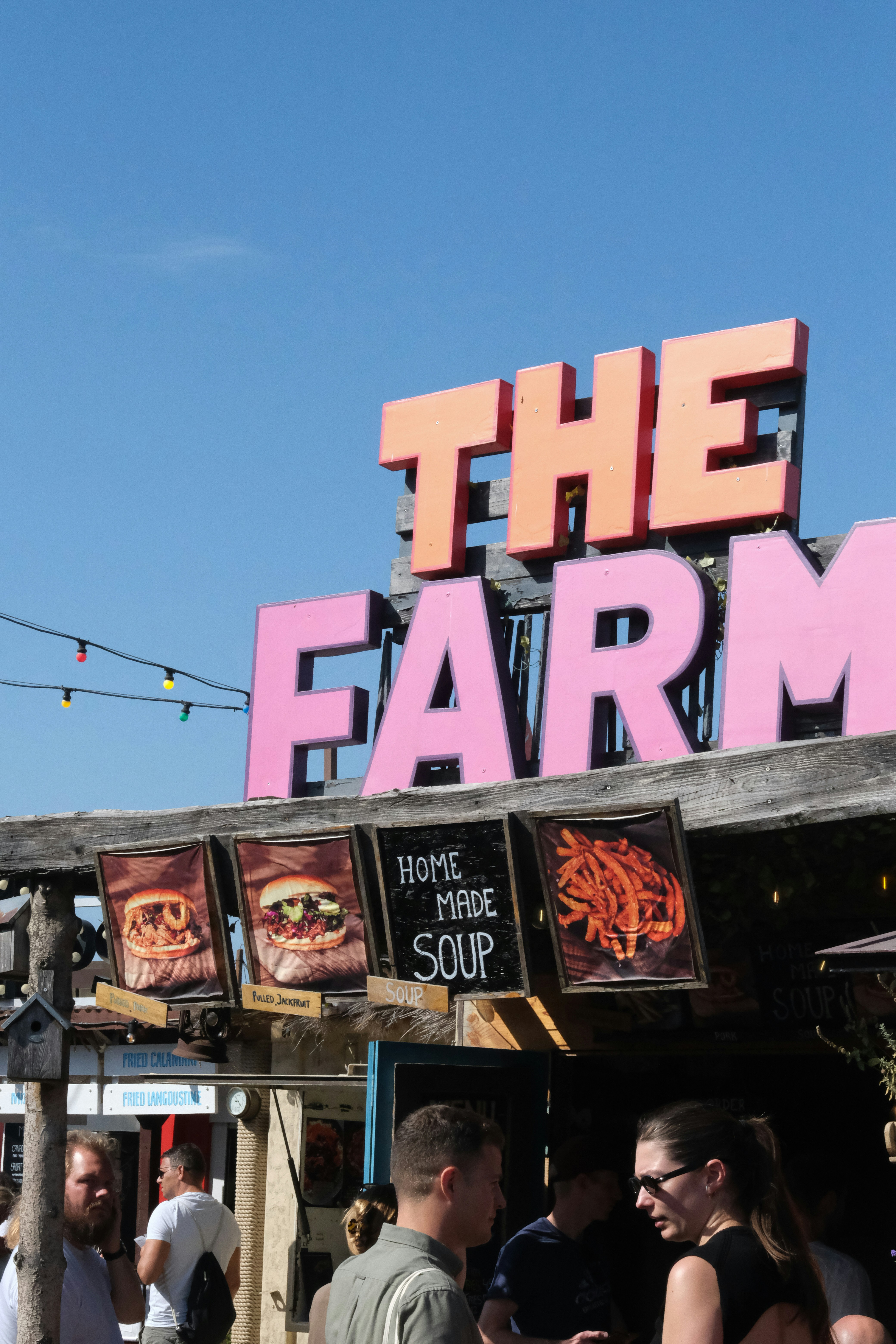 Pastel Promenade Under the Farm's Oversized Sign