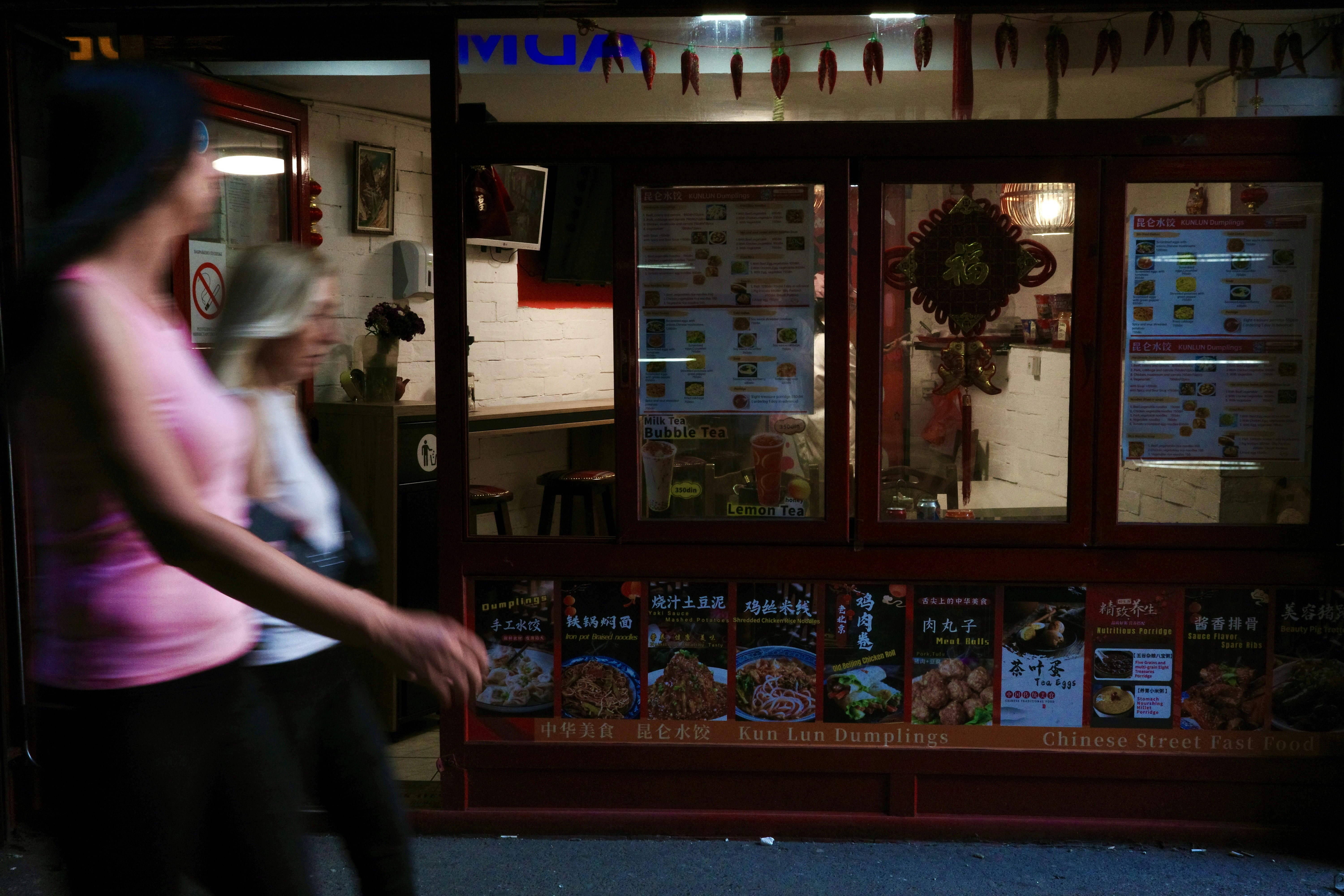 Night-Window Bazaar: Quiet Signage and Moving Figures