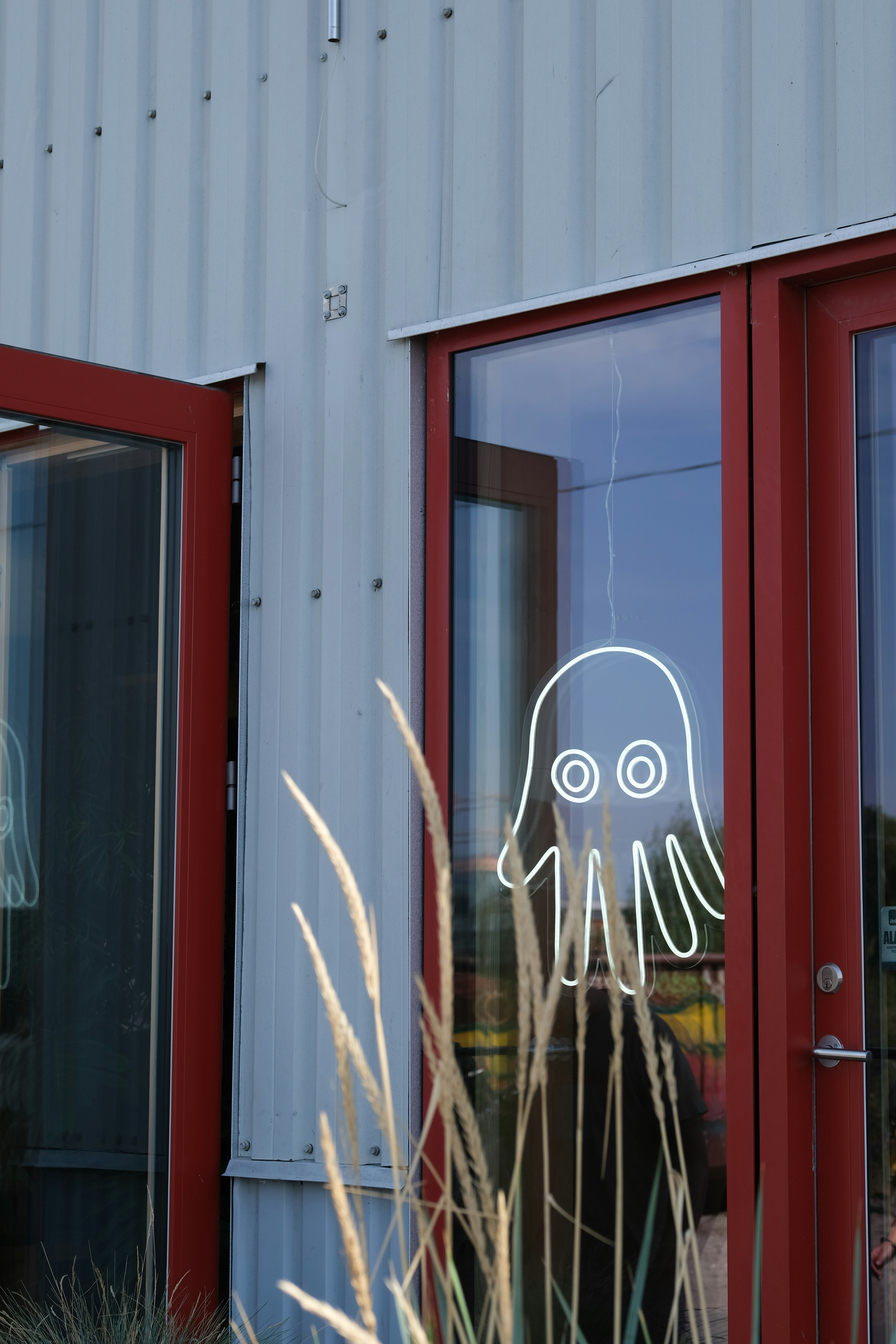 A window with a drawing of a squid on it photo – Free Reffen Image on ...