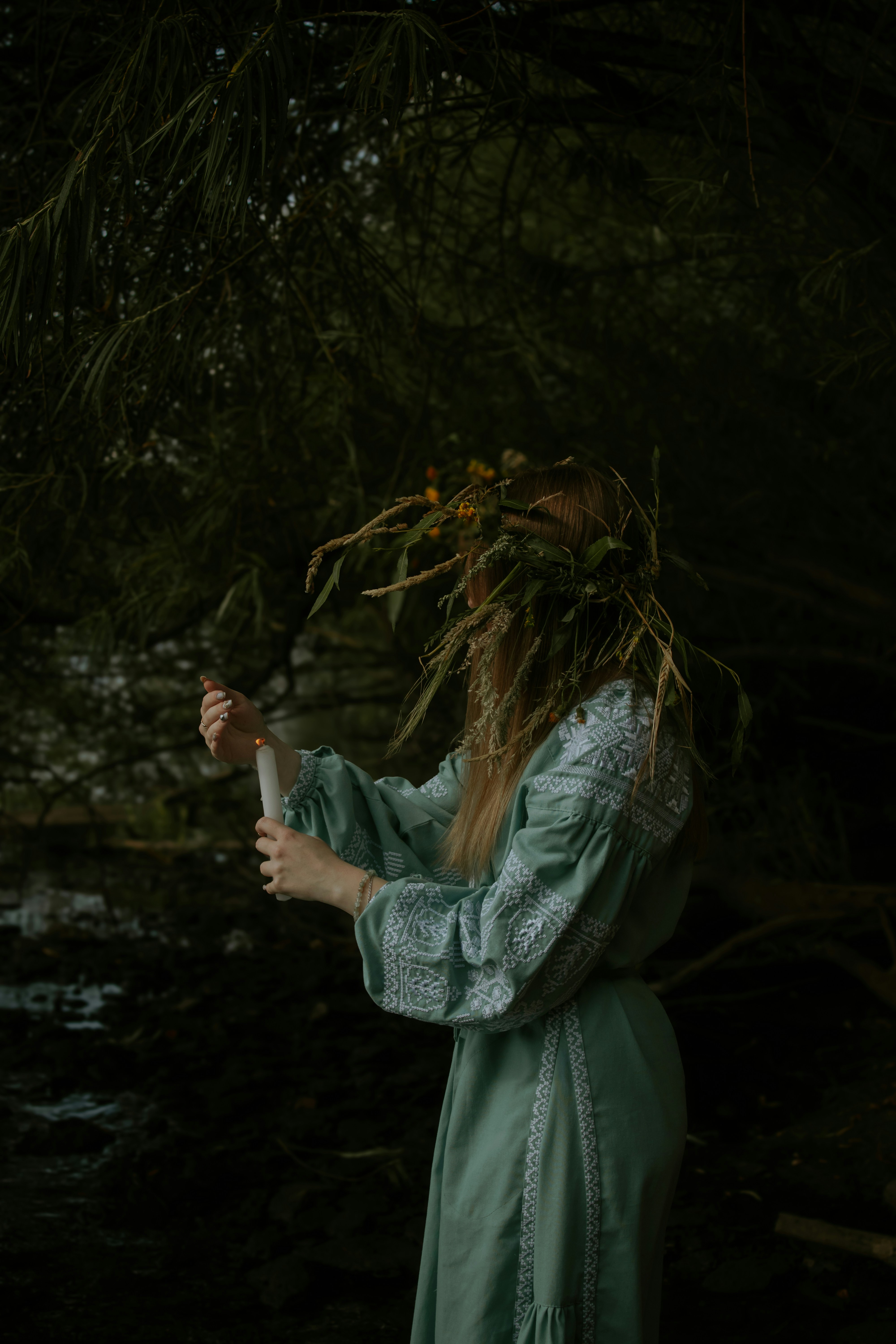 Candlelit Quiet in the Green Dress: A Portrait Beneath the Pines