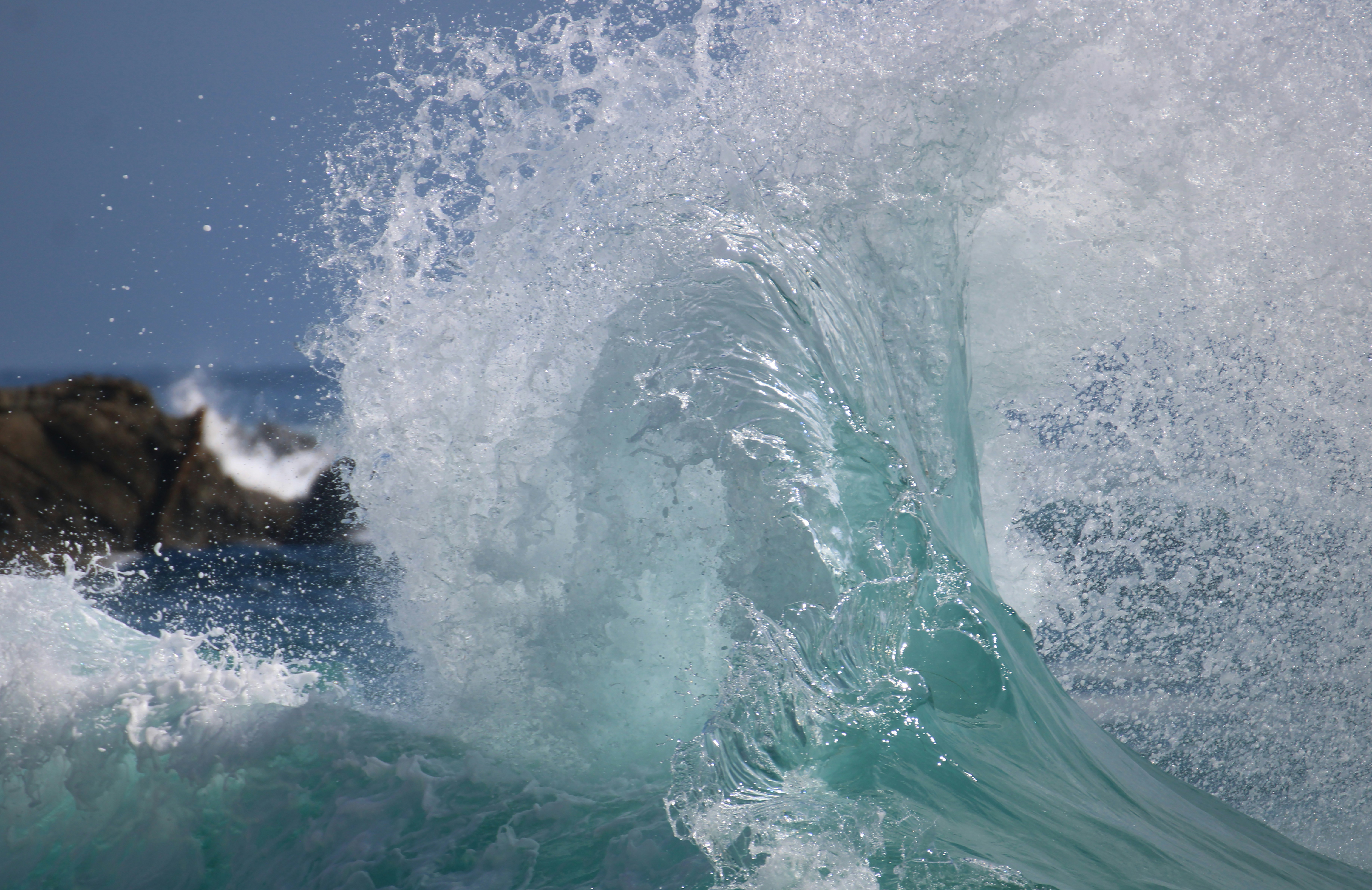 A large wave crashes into the shore of a beach photo – Free Wave Image ...