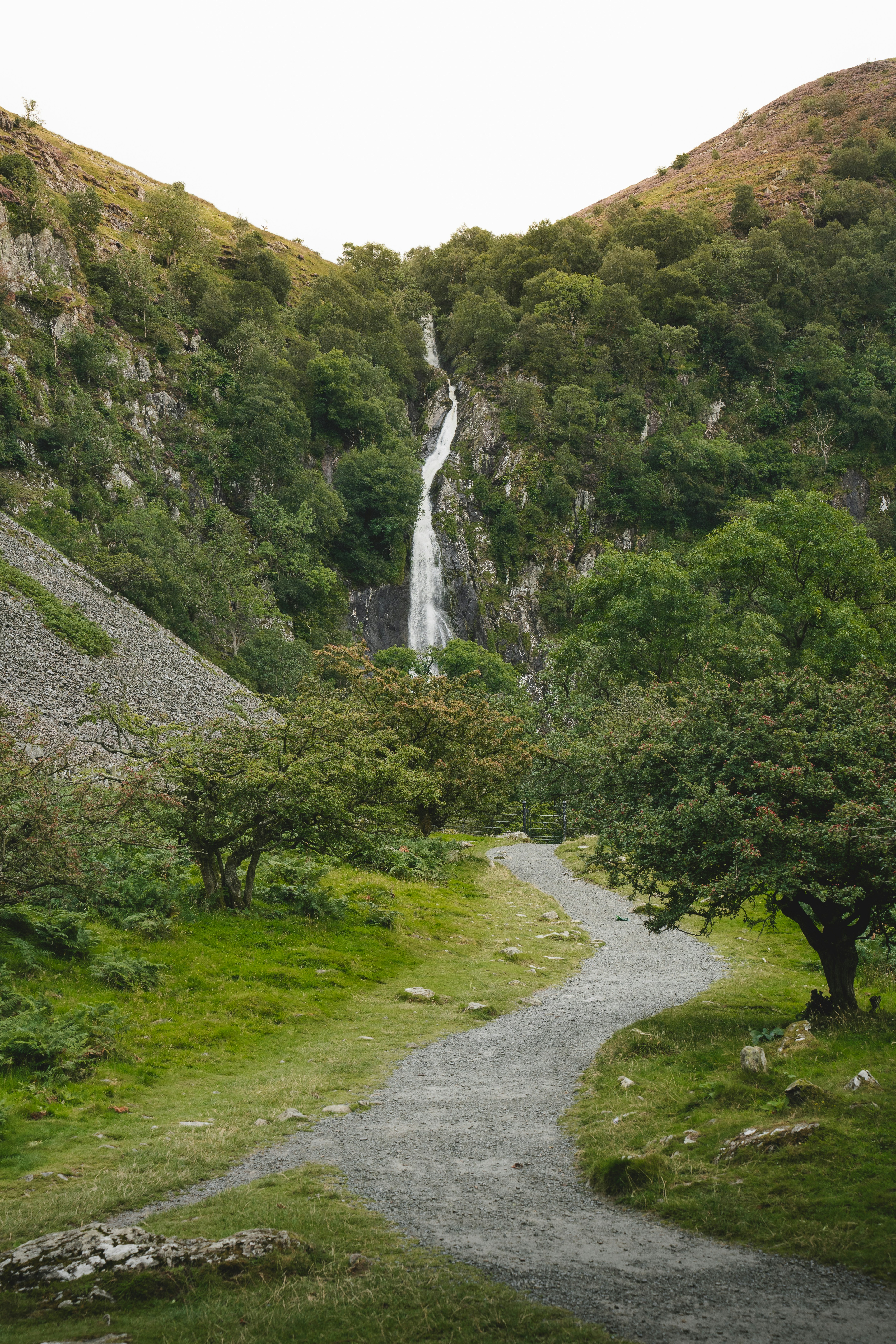 A path leading to a waterfall in the mountains photo – Free Rain Image ...