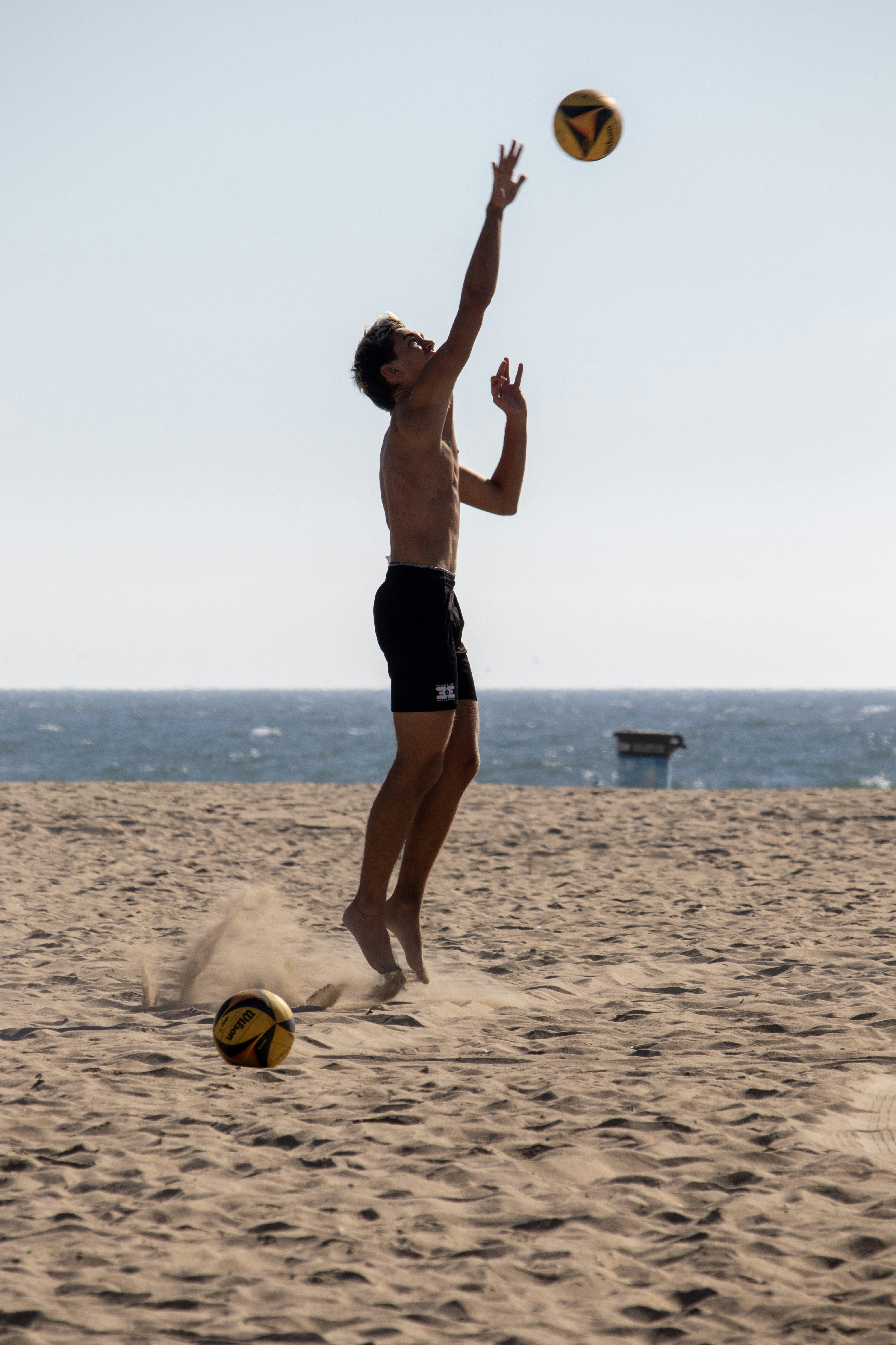 A boy plays beach volleyball with his friends in Huntington Beach, California.