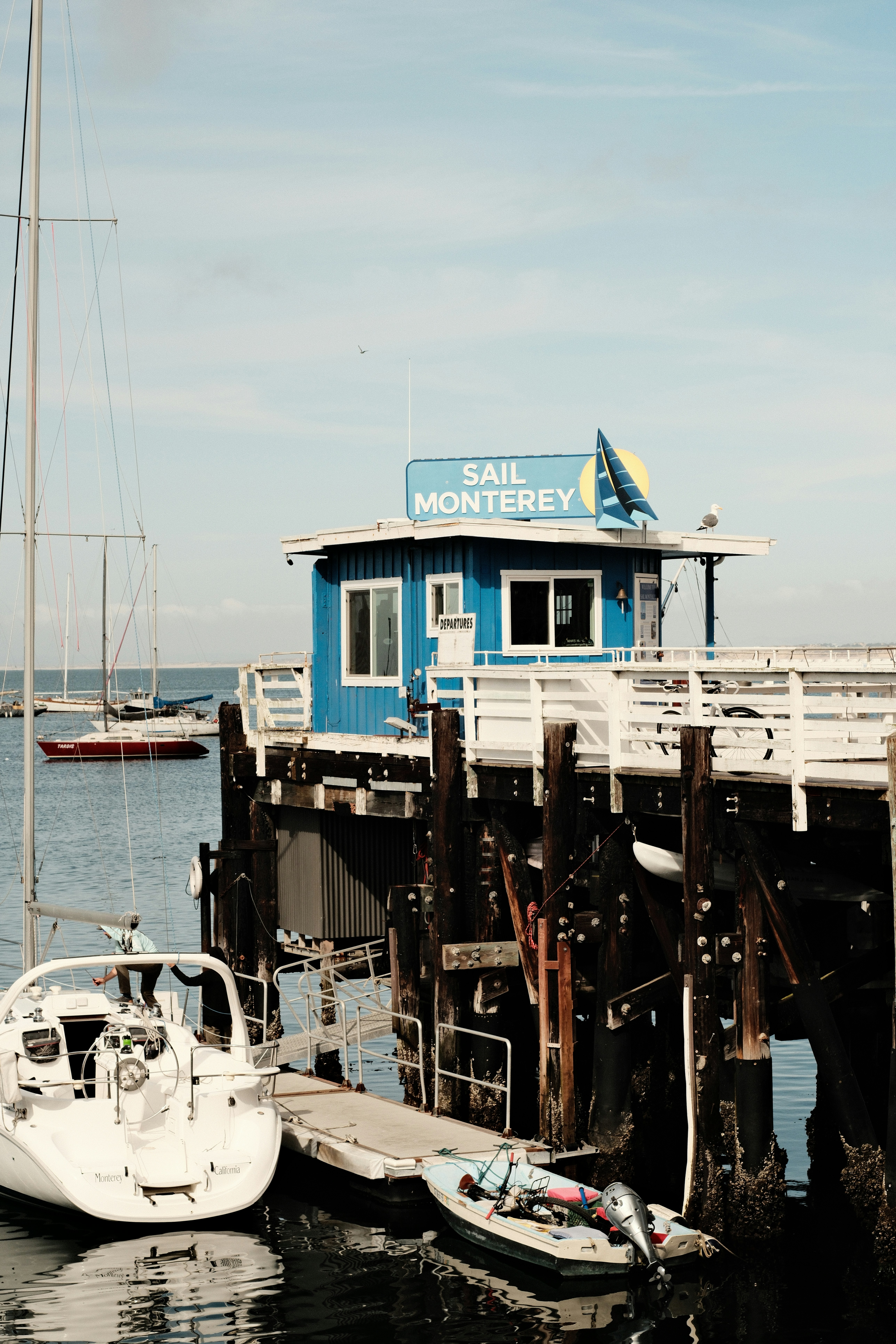 Sail Monterey: Blue Pier Shack Rising Over the Quiet Harbor